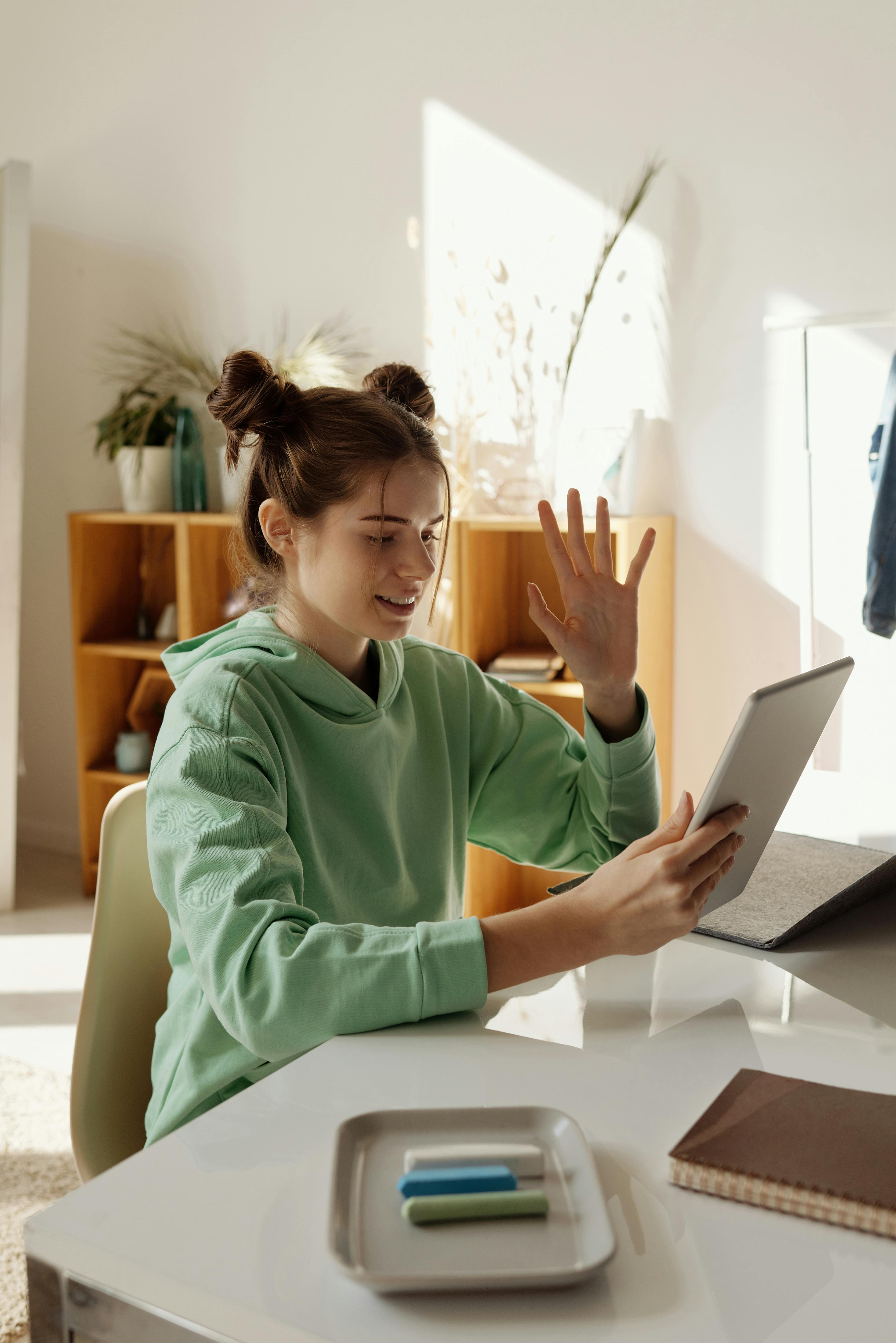 Teenage Girl Saying Hello During Video Call · Free Stock Photo