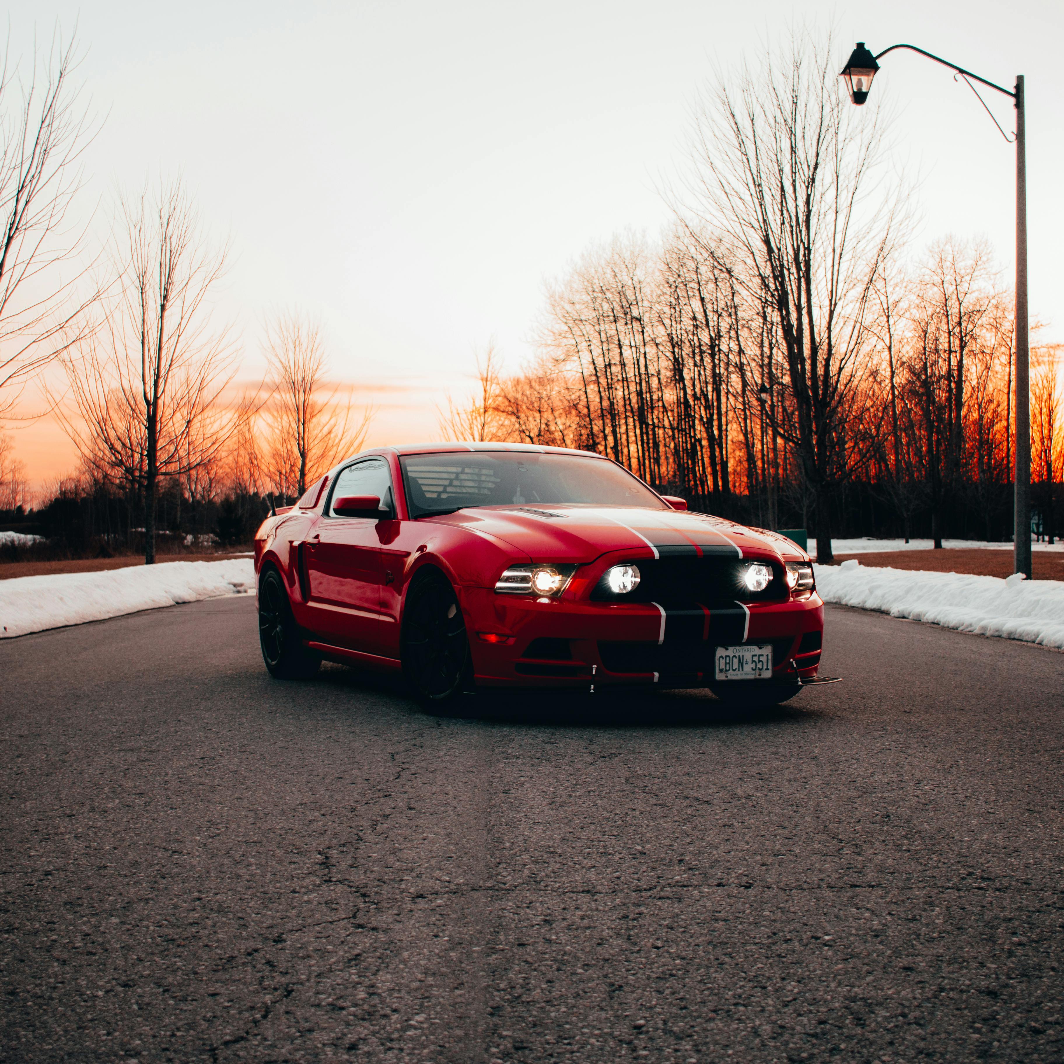 Red Sports Car on the Asphalt Road During Sunset · Free Stock Photo