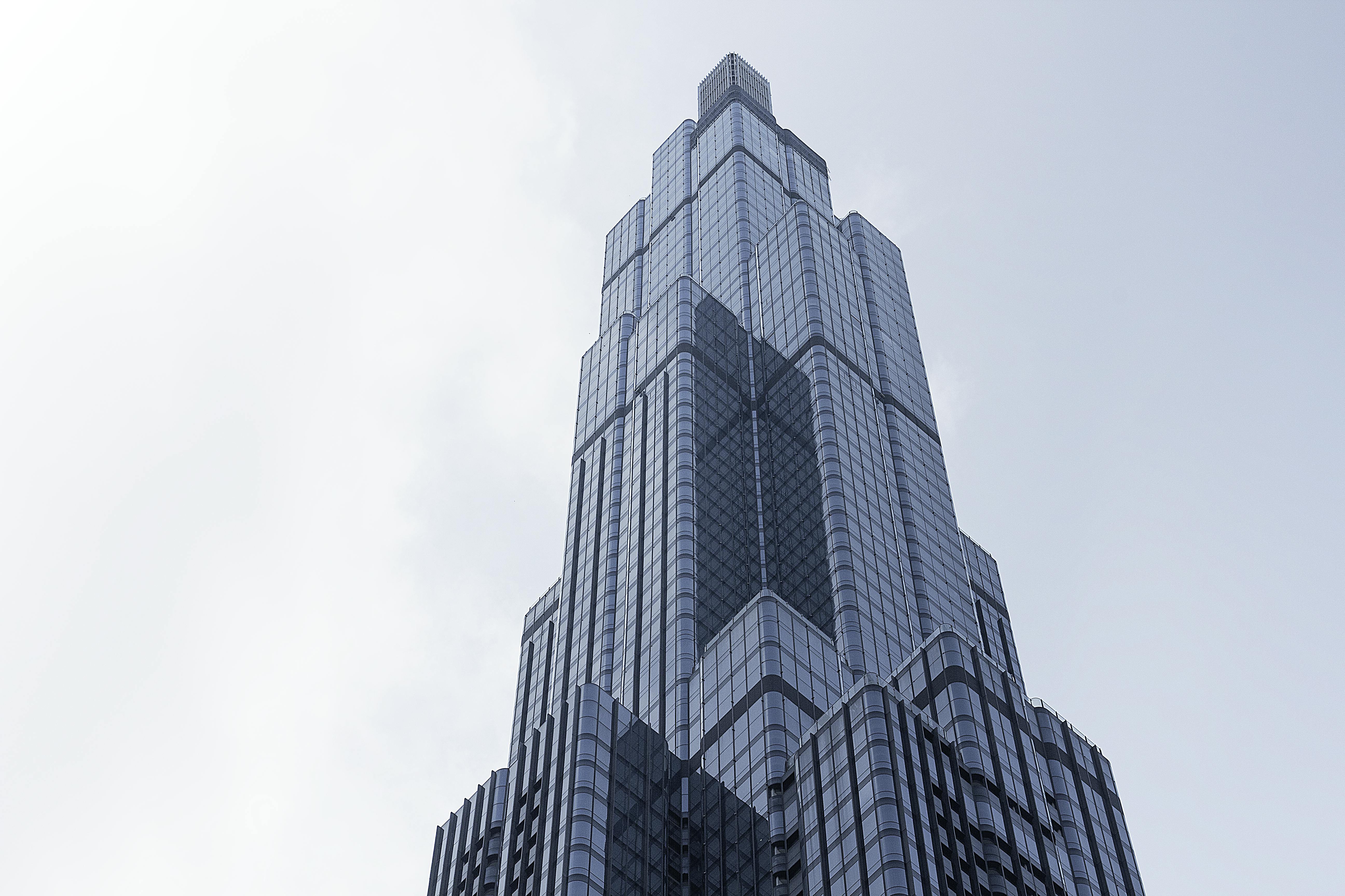 Modern style skyscraper facade under sky in city · Free Stock Photo