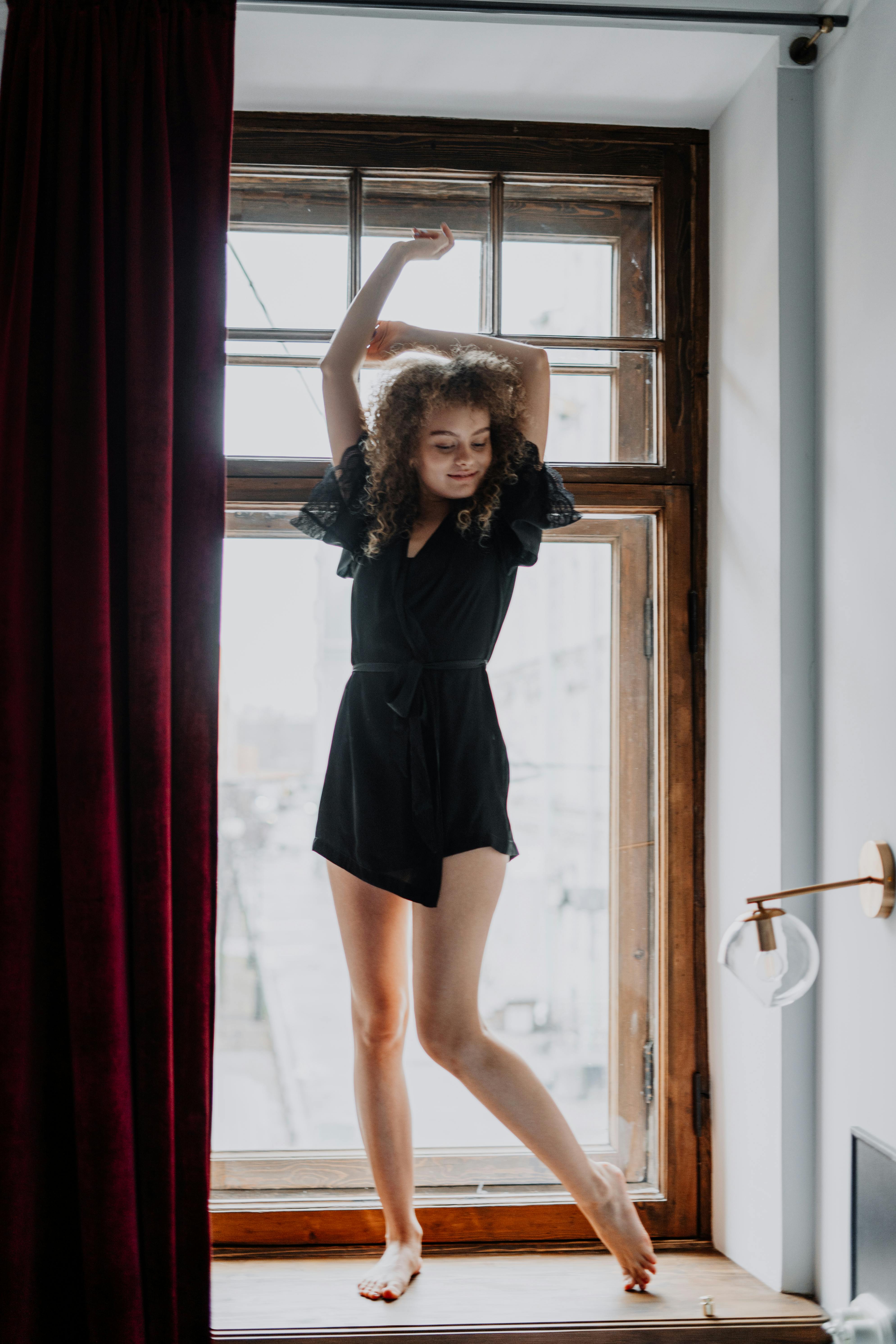 Woman in Black Dress Sitting on Window · Free Stock Photo