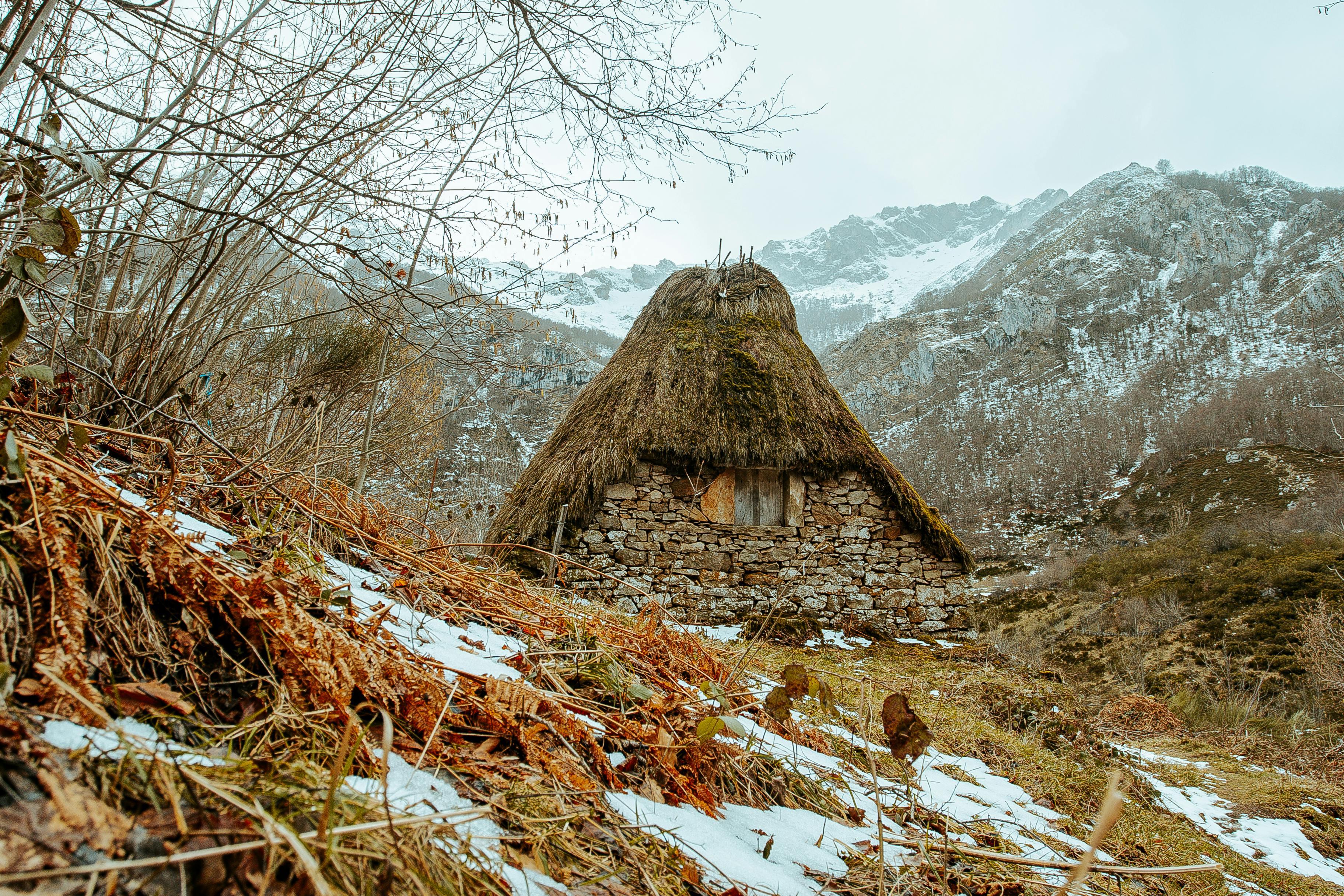 Stone hut in mountains on winter day · Free Stock Photo
