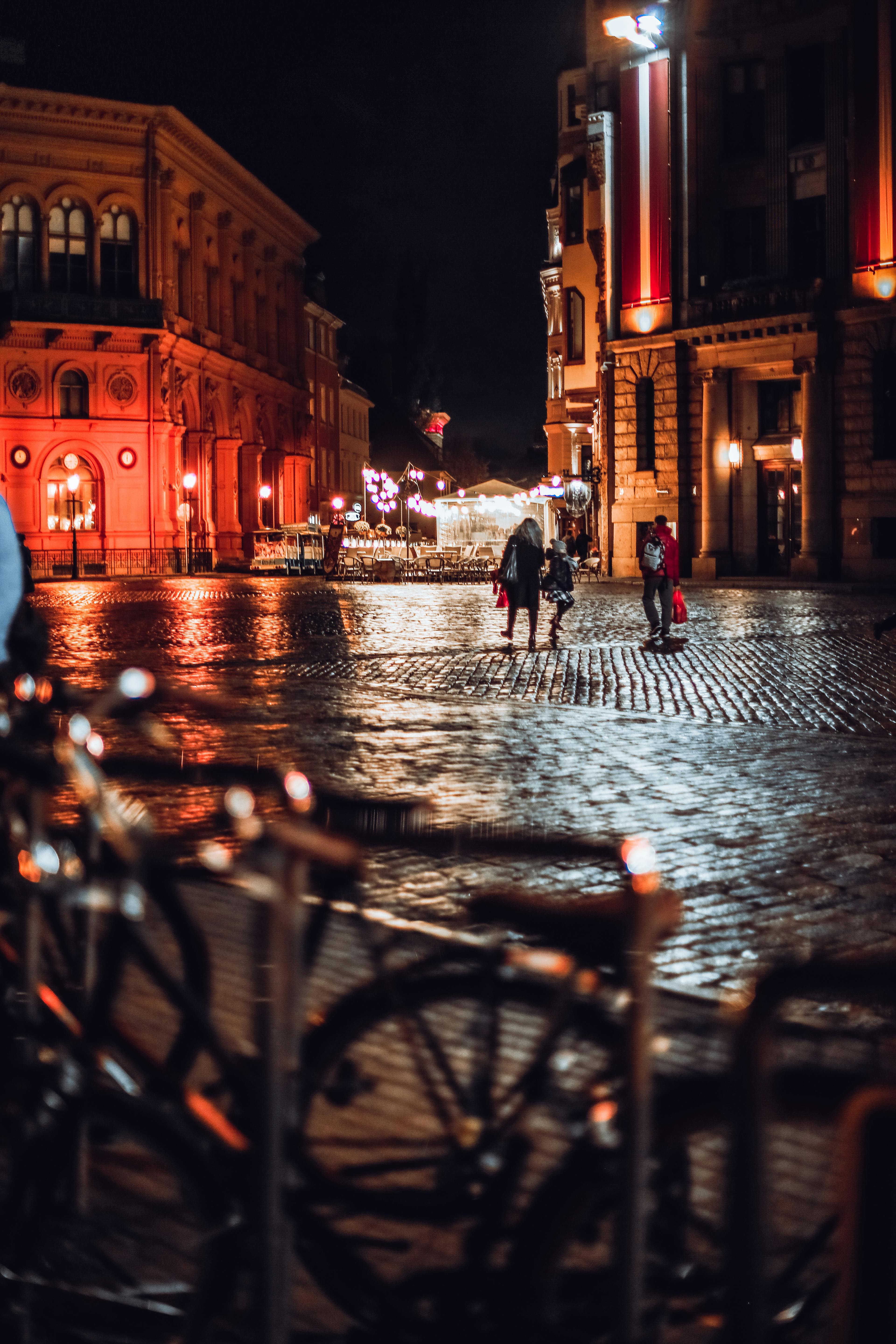Old city street with people during nighttime · Free Stock Photo