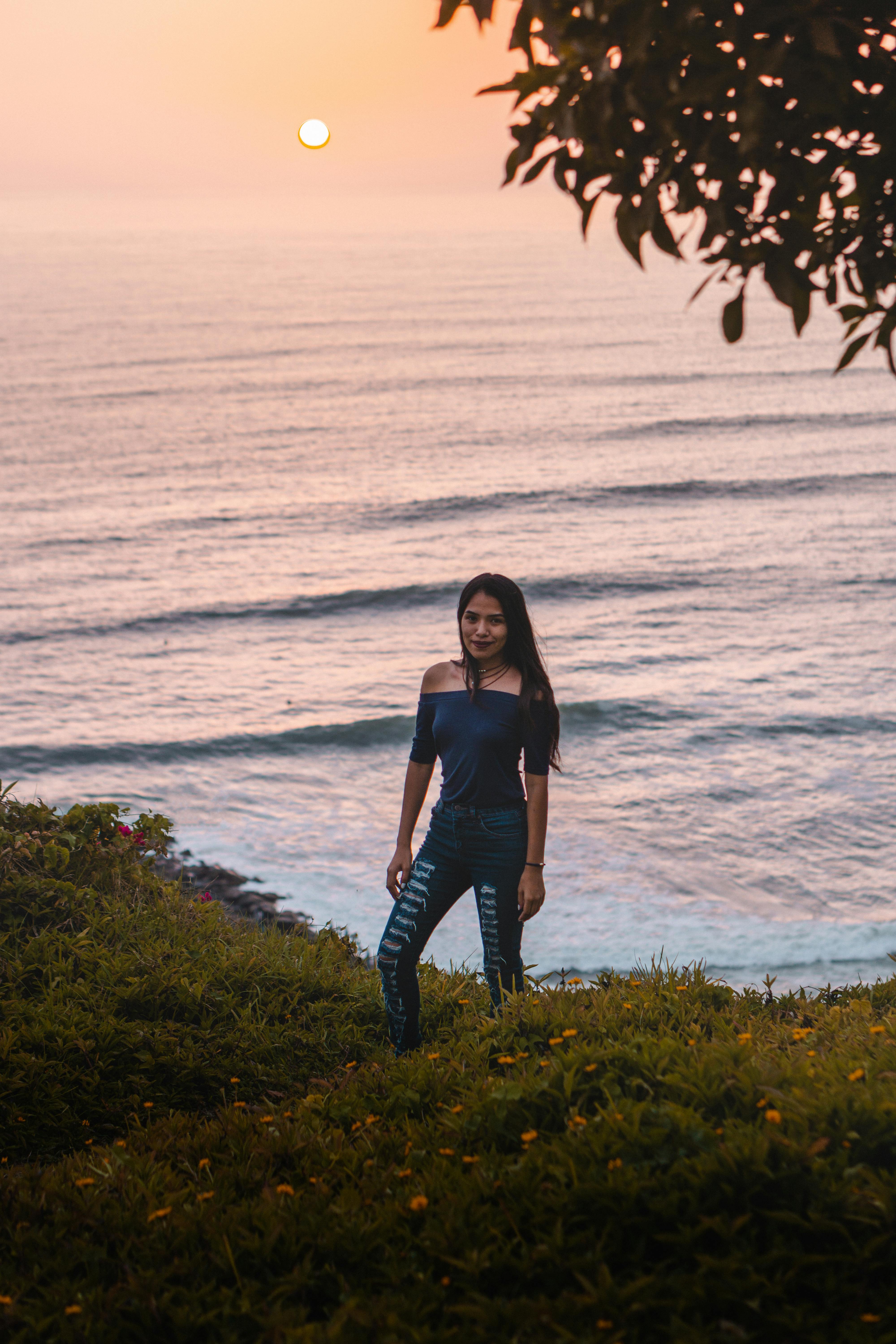 Woman Standing on Seashore · Free Stock Photo