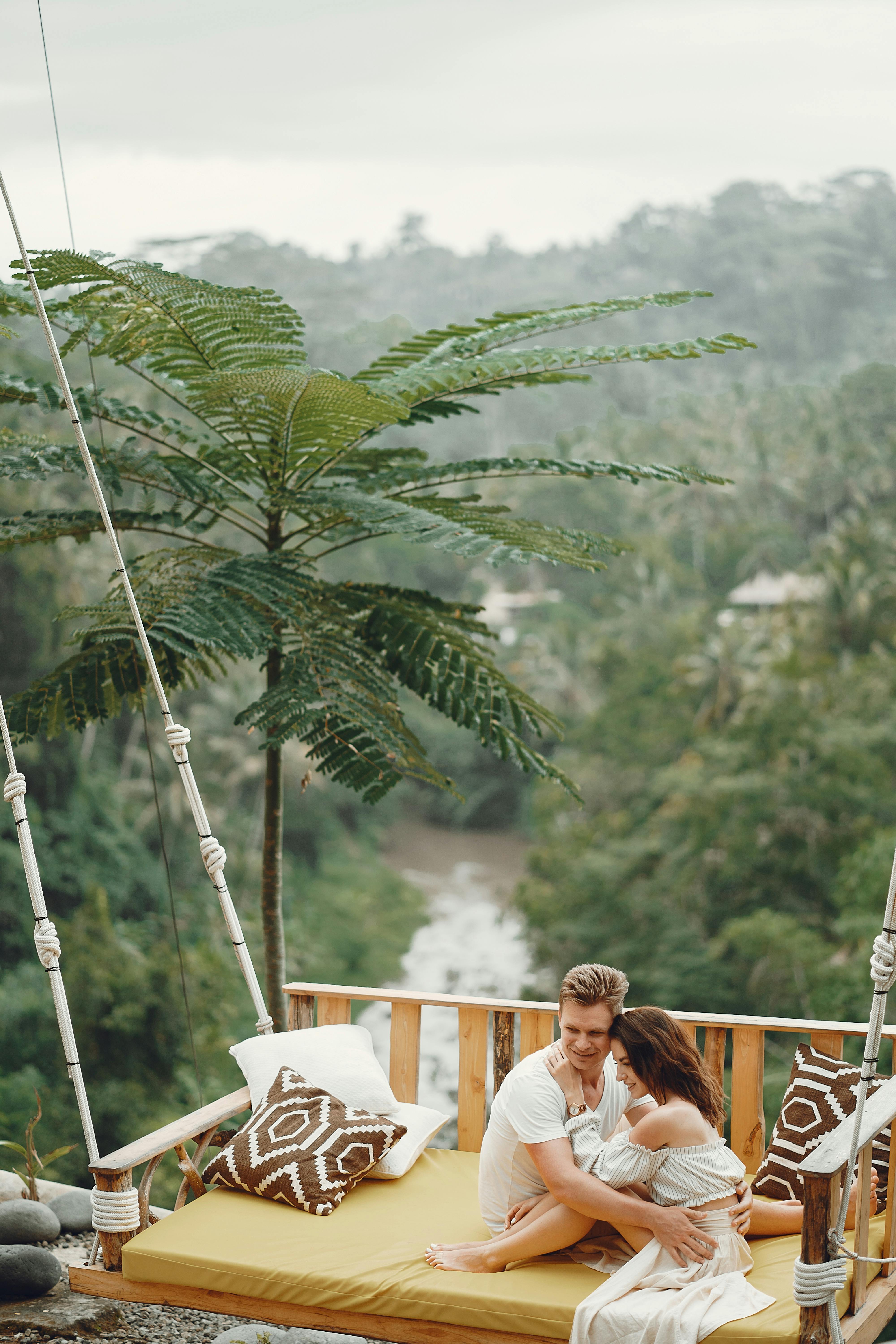 Relaxed couple resting on hanging swing hammock · Free Stock Photo