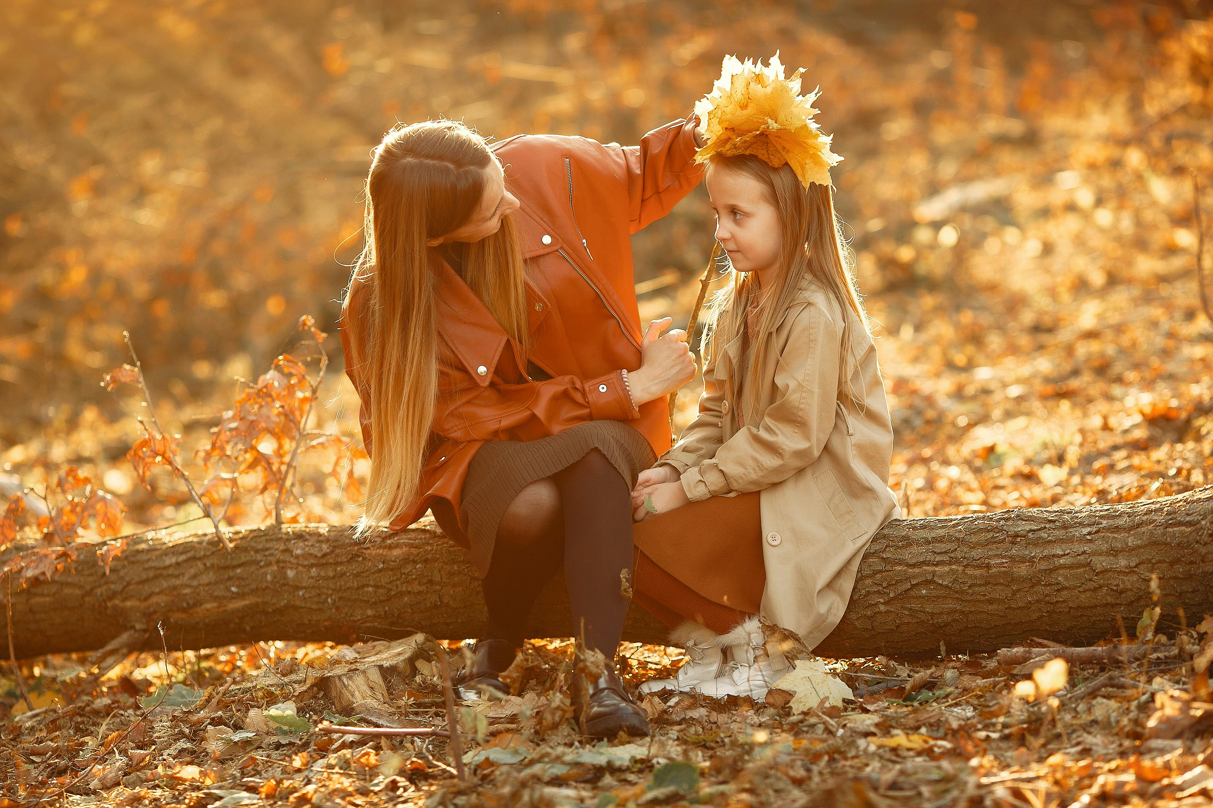 Happy mother and daughter in autumn forest · Free Stock Photo