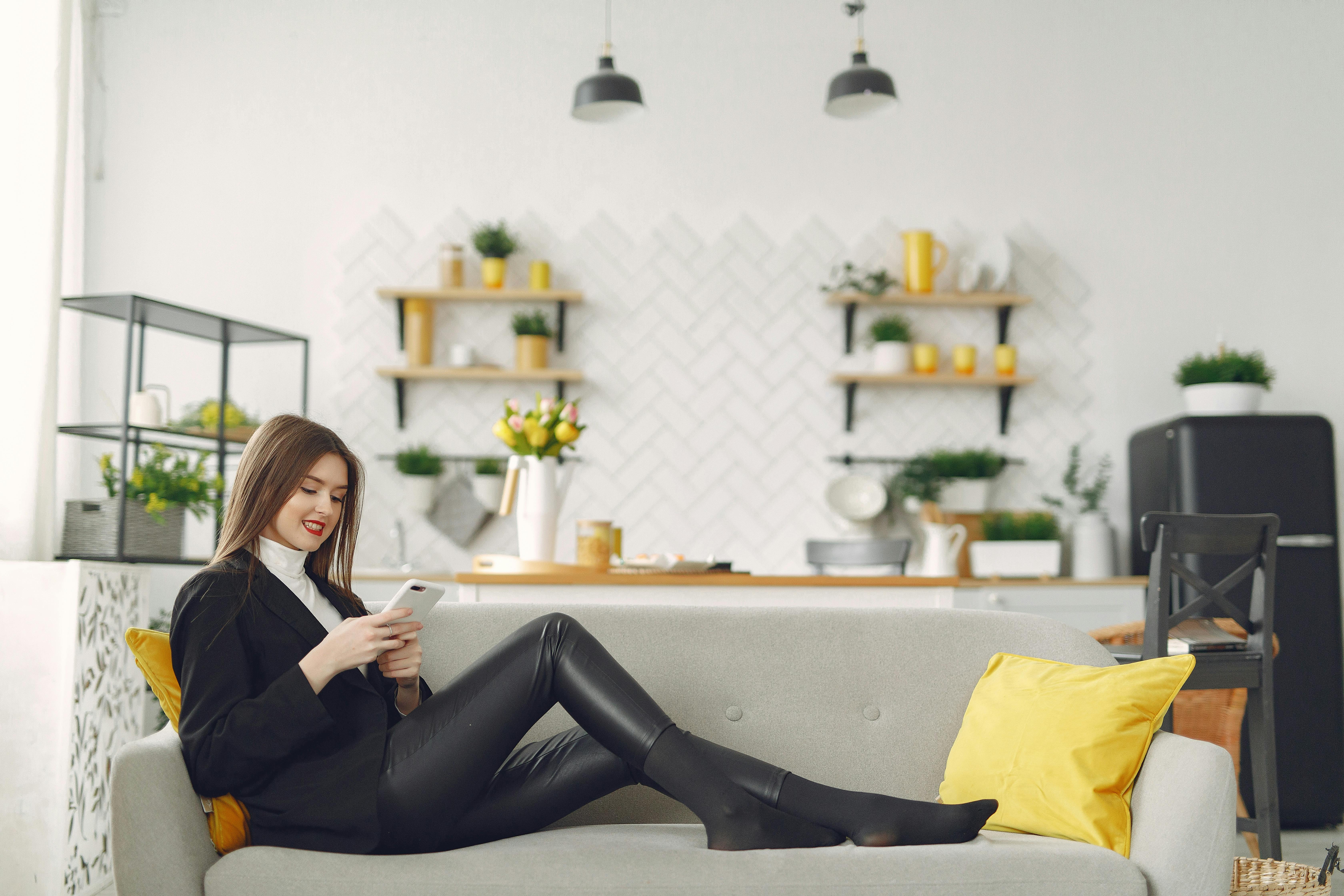 Happy Woman Pressing Phone On Couch With Plain Background Photos ...