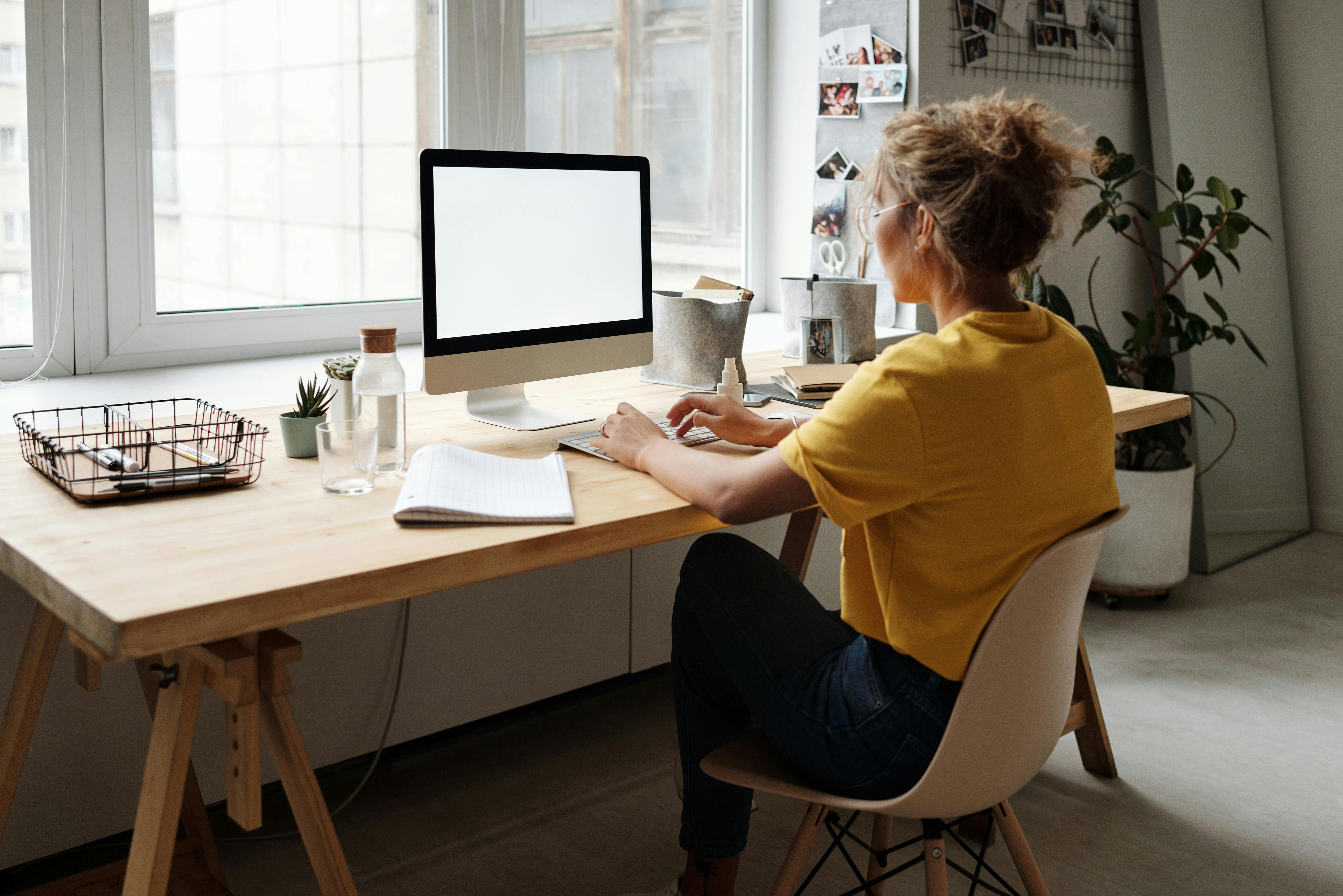 Woman in Yellow Shirt Sitting on Chair in Front of Computer Monitor ...