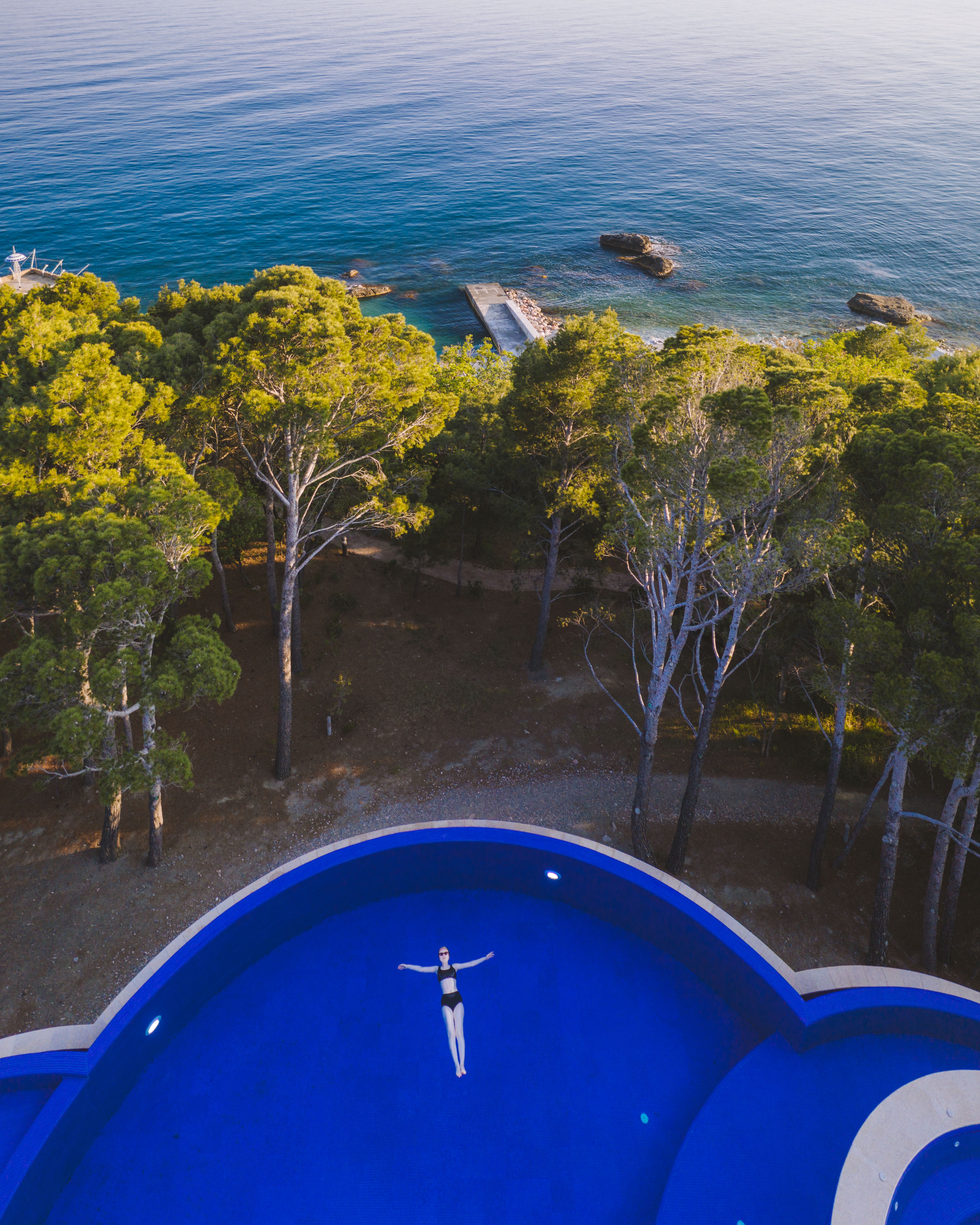 Aerial Footage of Woman floating on a Swimming Pool · Free Stock Photo