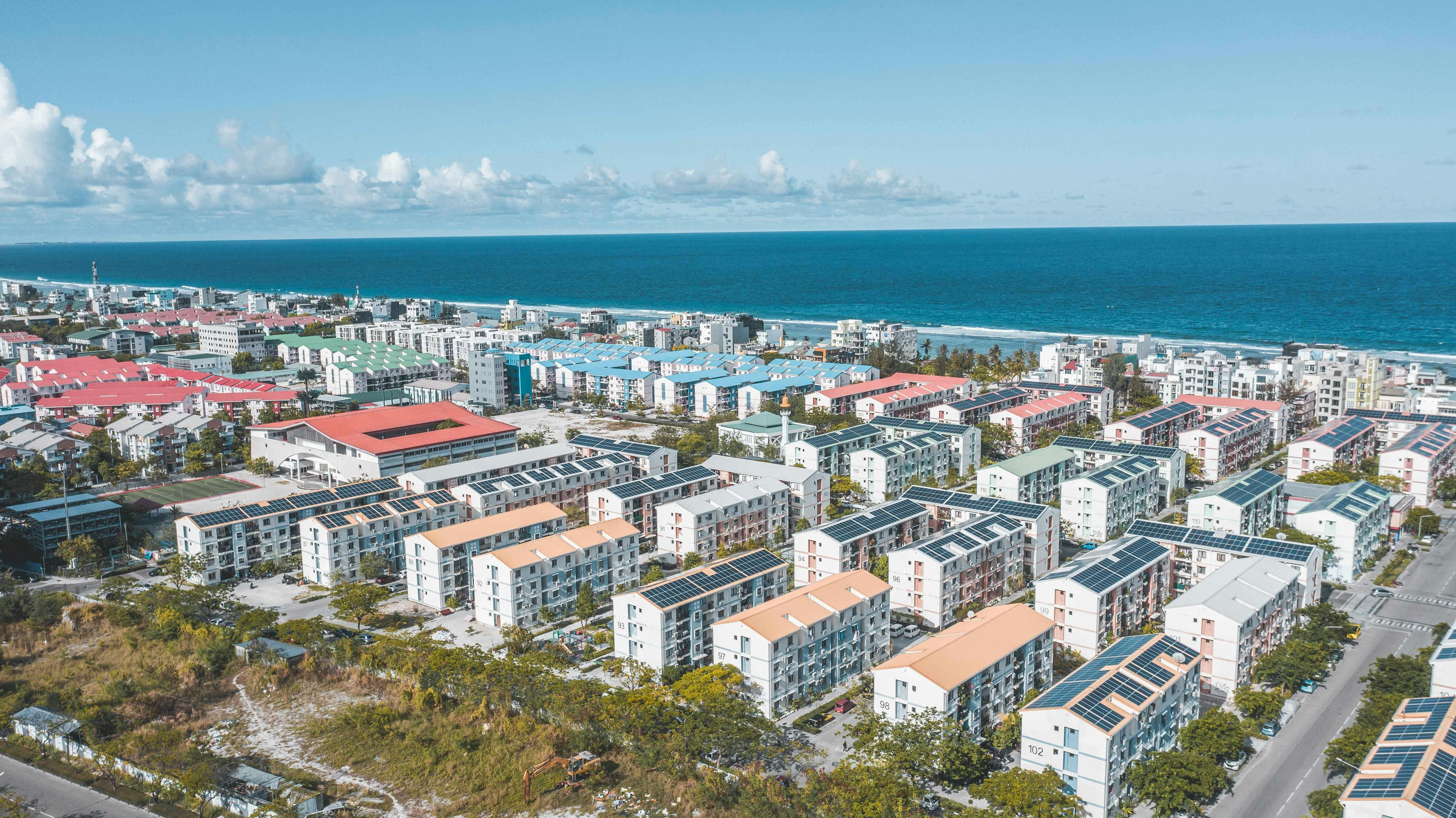 Modern housing complex exteriors near ocean with horizon · Free Stock Photo