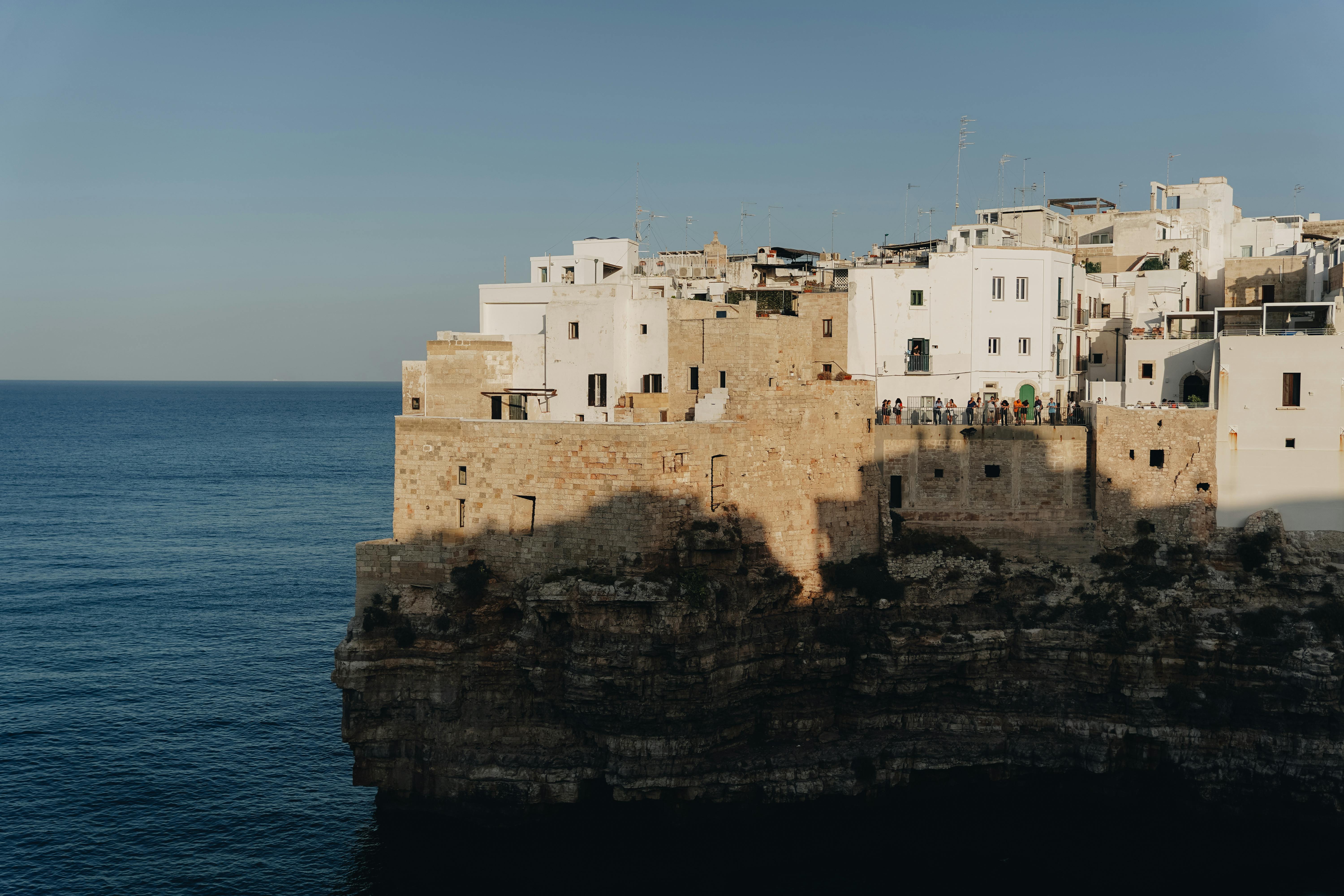 Concrete Buildings on Cliff Edge by the Sea · Free Stock Photo