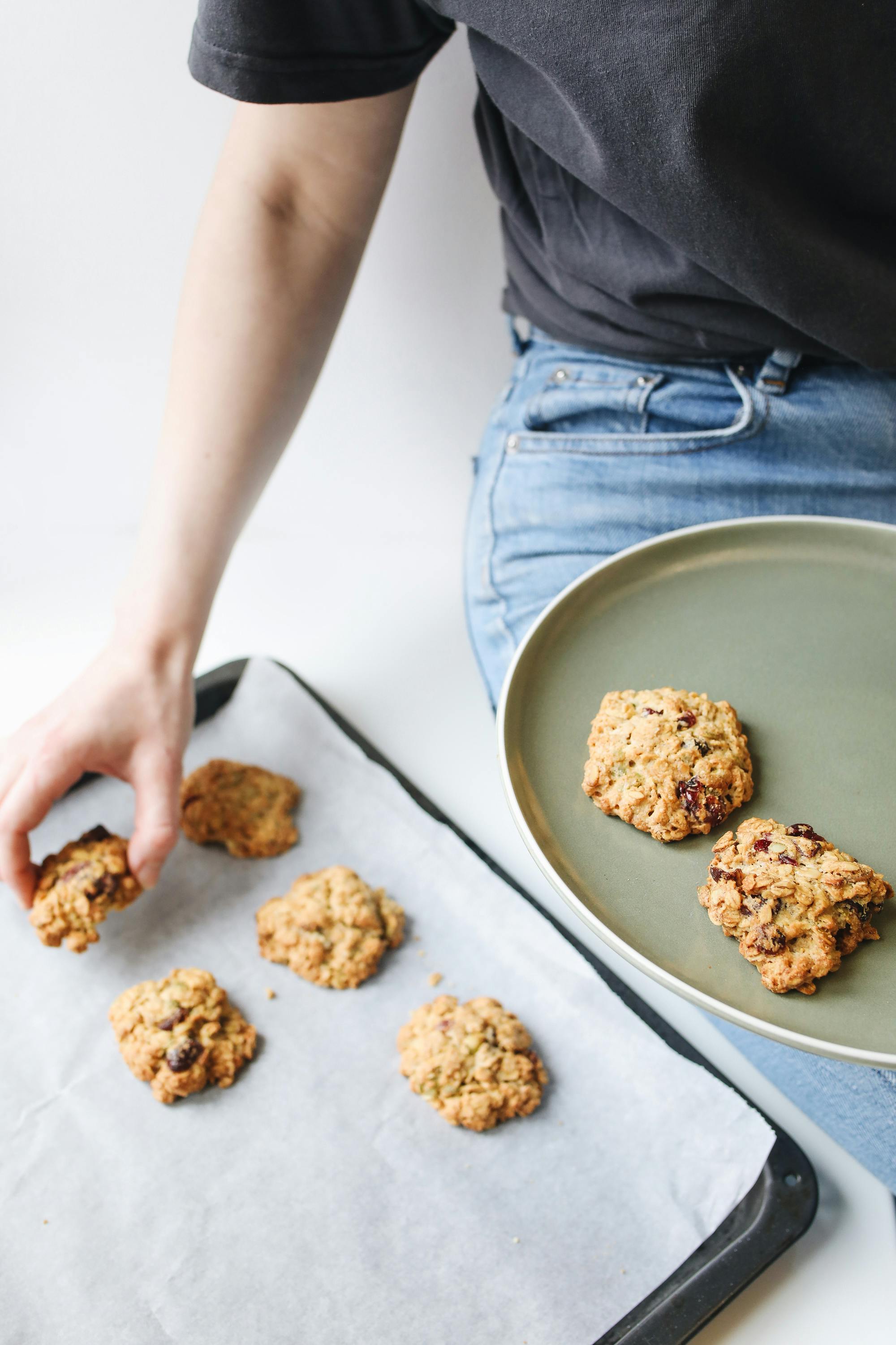 Person placing a Newly Baked Cookie · Free Stock Photo
