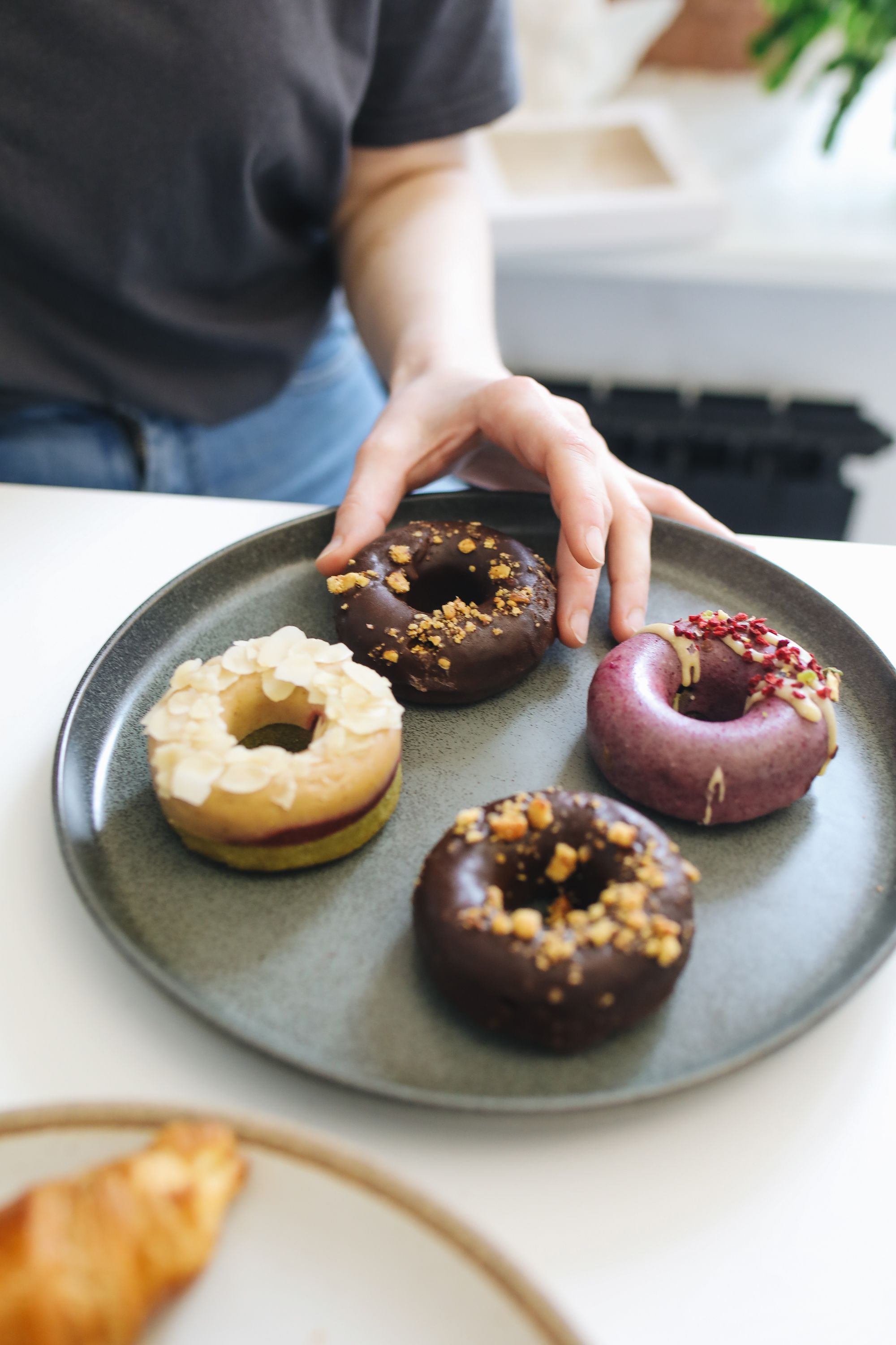 Man Reaching for Doughnuts on Tray · Free Stock Photo