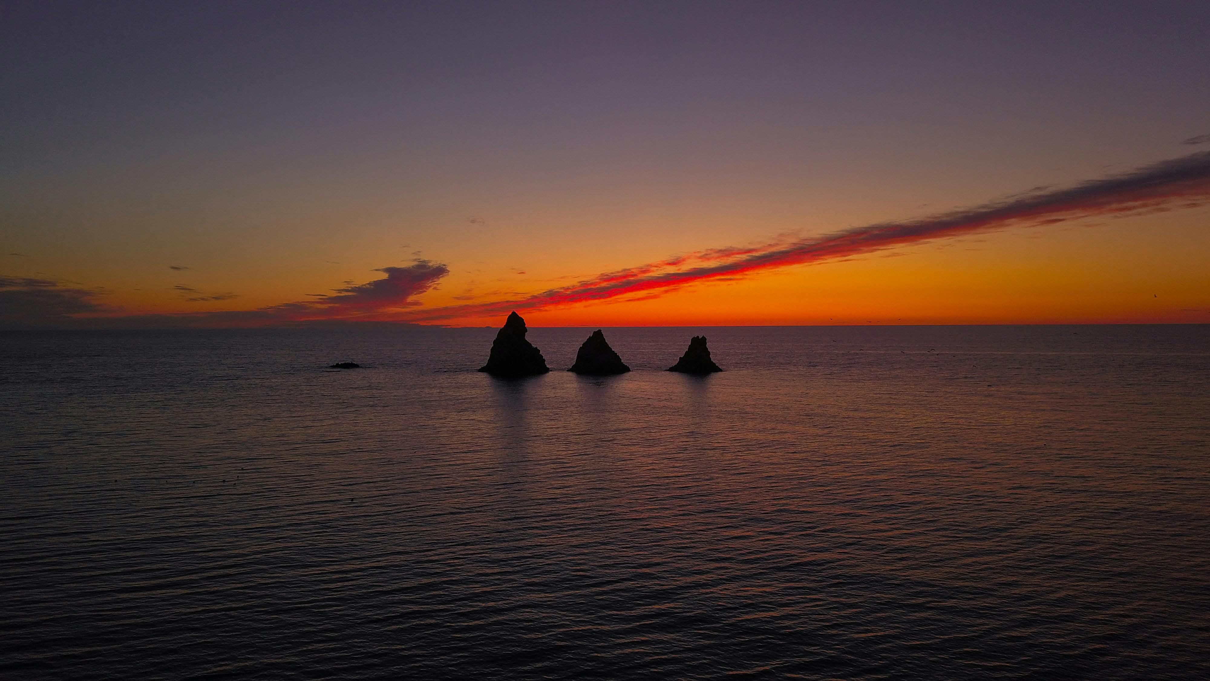 An Aerial Photography of a Rock Formations Near the Body of Water ...
