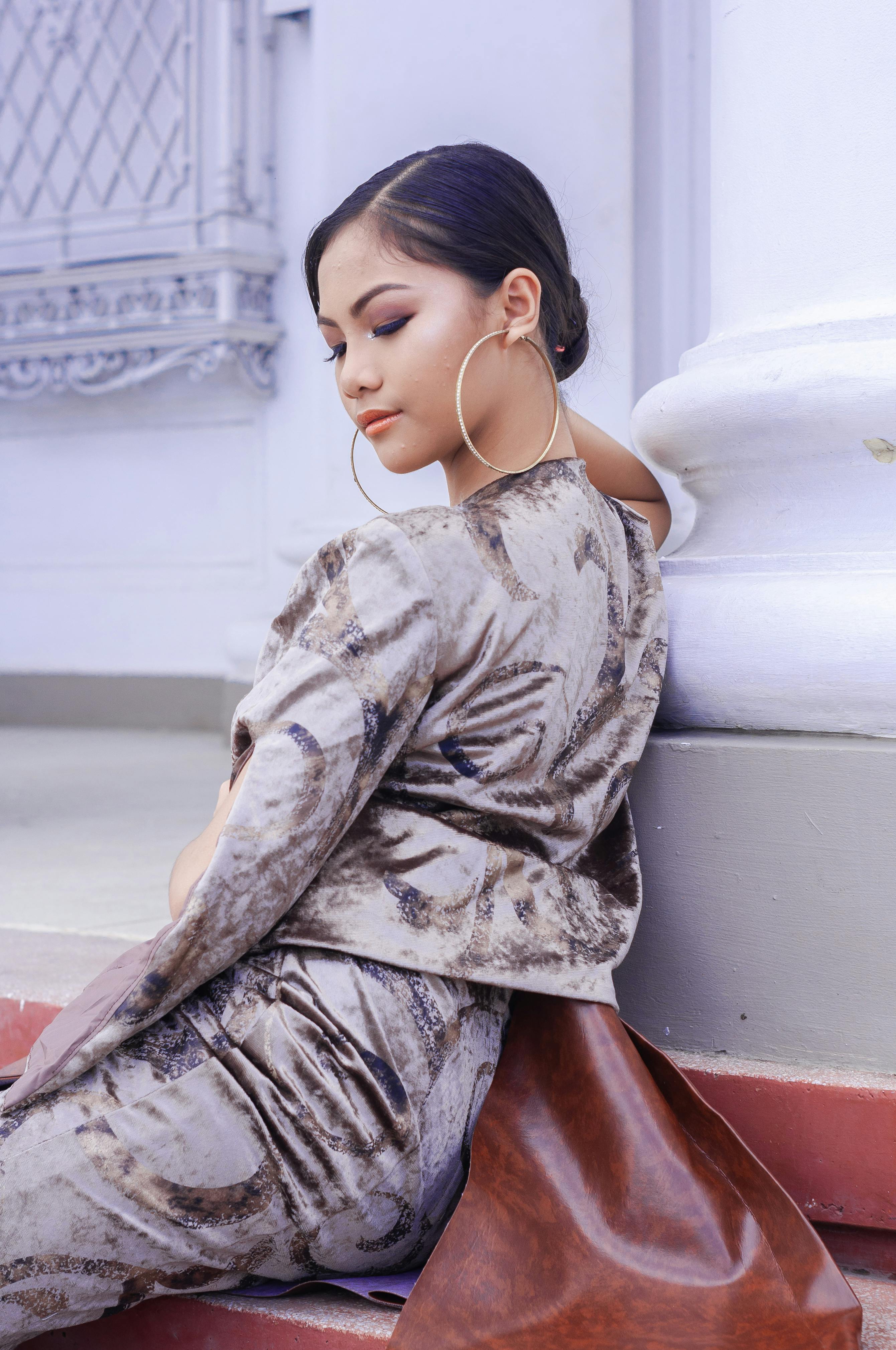 Self esteem female model sitting on floor in studio · Free Stock Photo