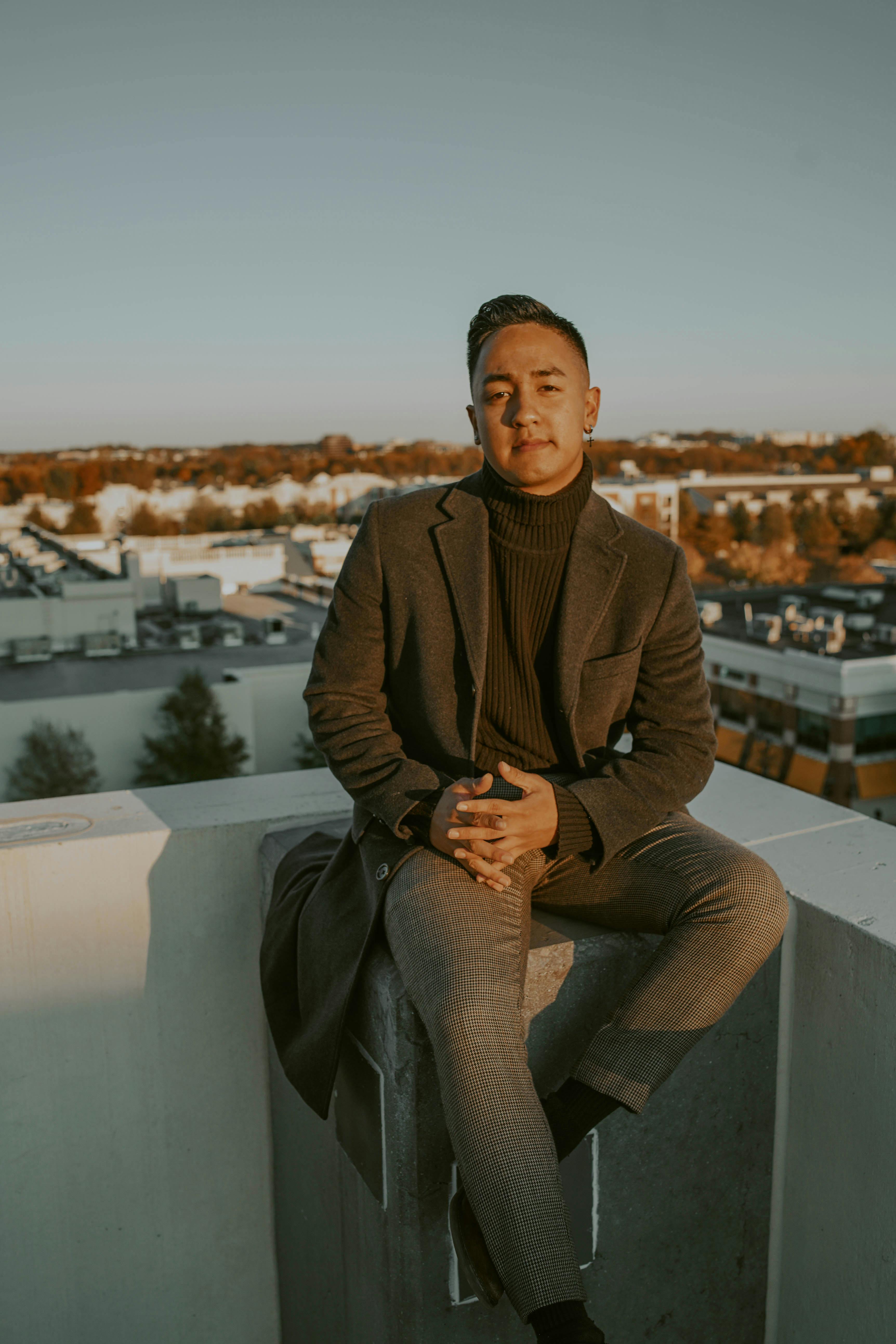 Trendy young ethnic man on rooftop · Free Stock Photo