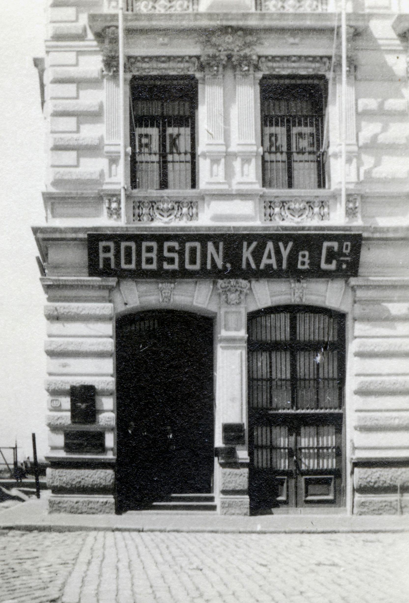 A Red Squid Sculpture Under a Store Signage · Free Stock Photo