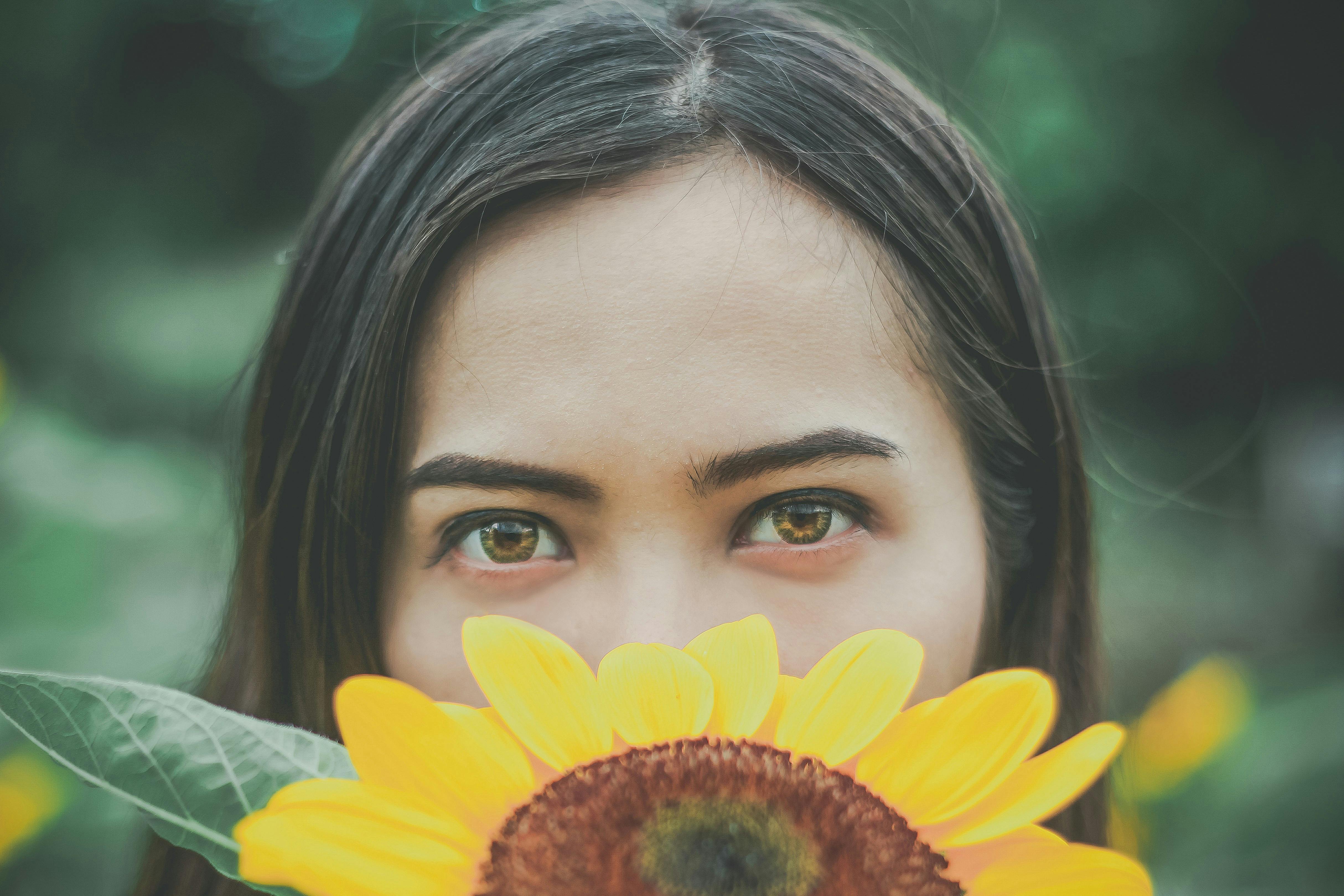 Sunflower Near a Woman's Face · Free Stock Photo