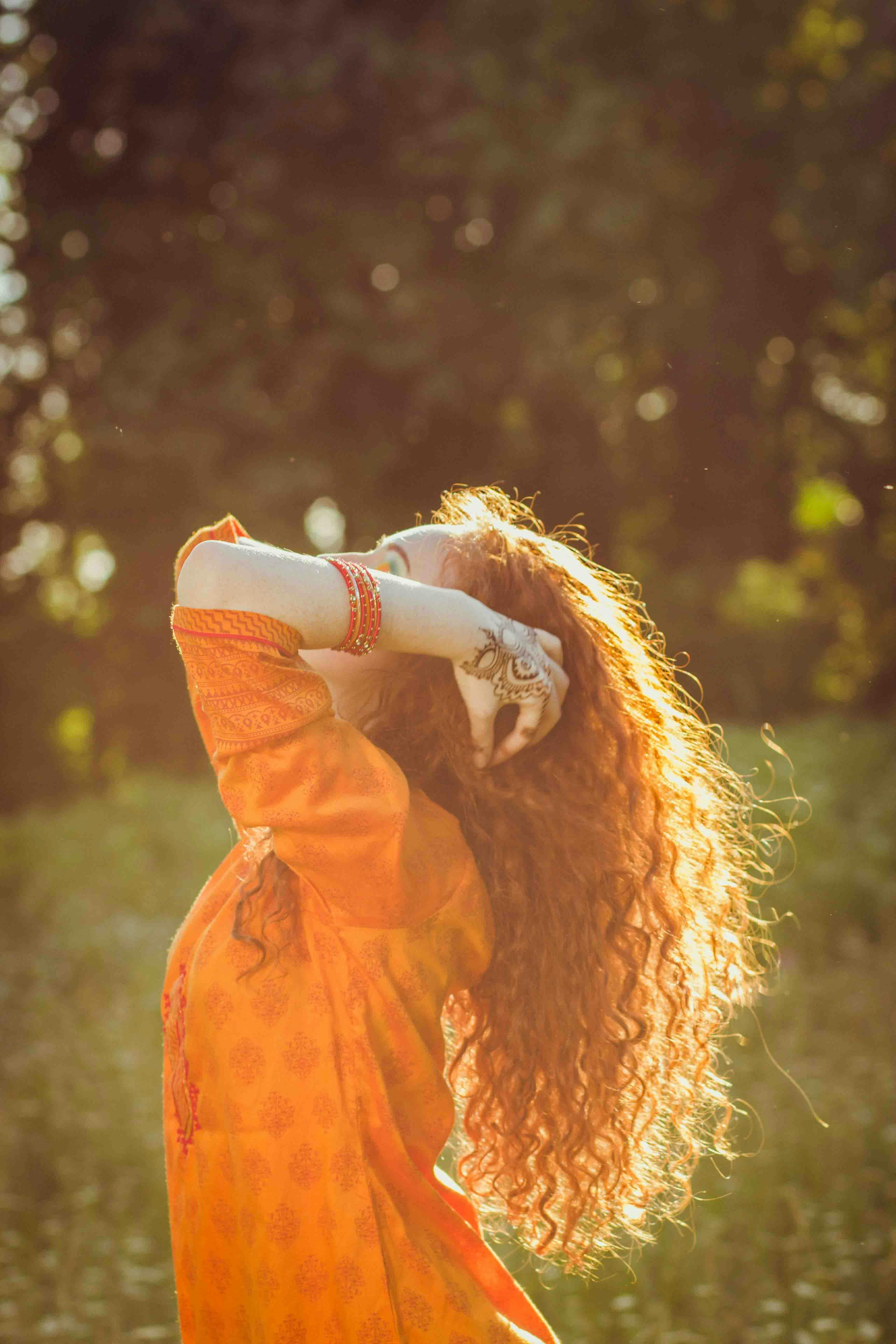 Side View Photo of Girl Standing Near Vanity Mirror · Free Stock Photo