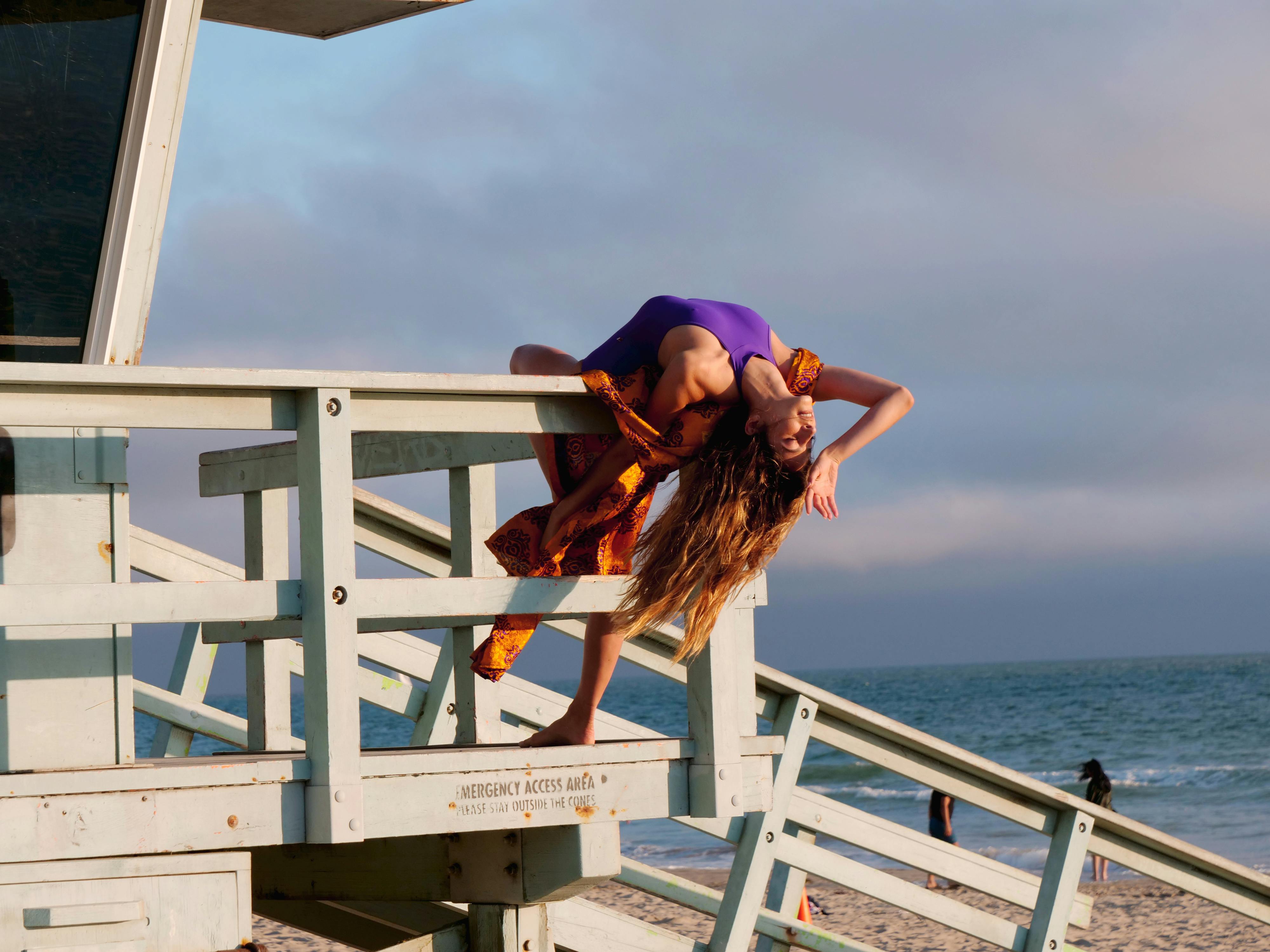 Seductive woman leaning to railing of fence · Free Stock Photo