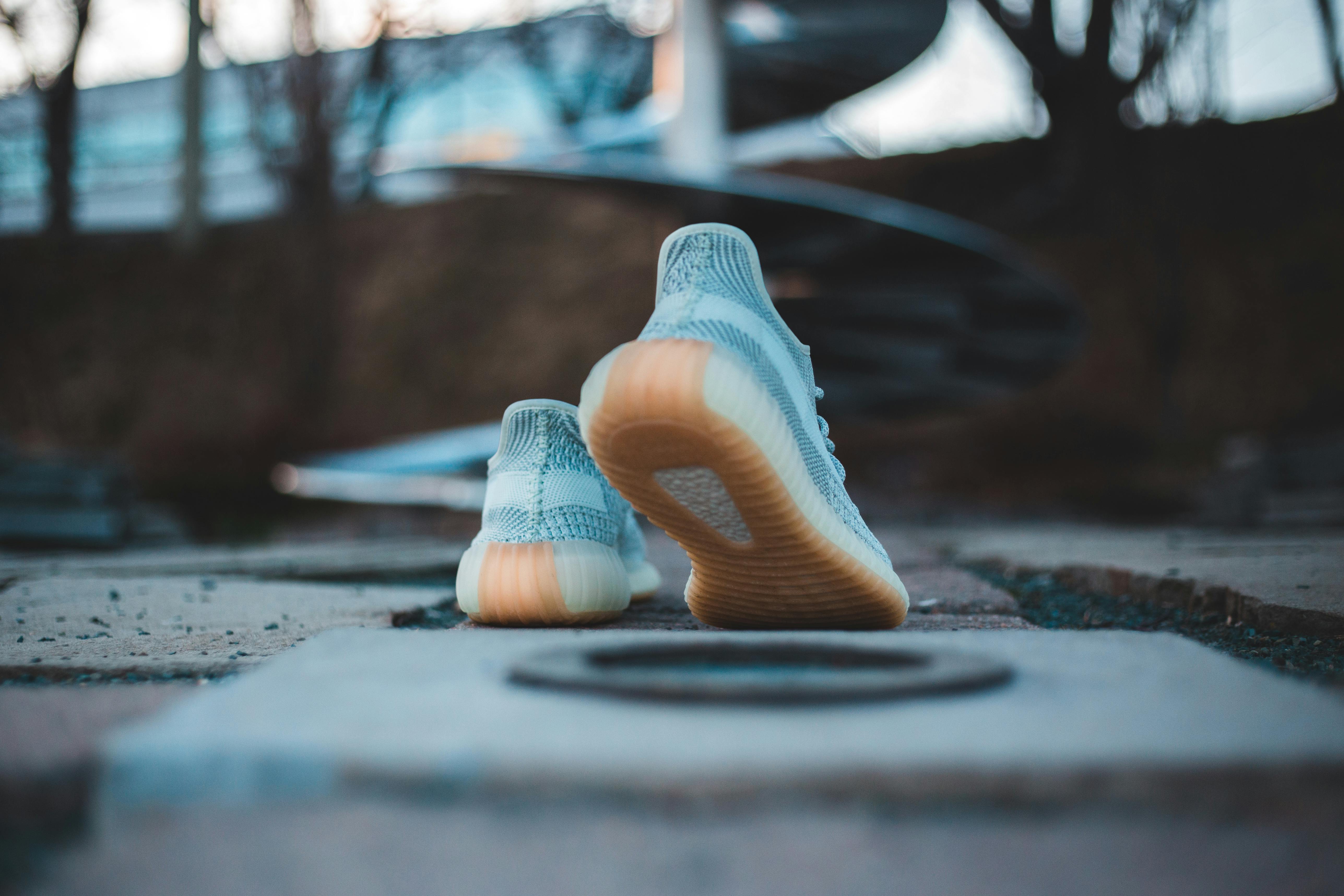 Modern style sneakers on street pavement in town · Free Stock Photo