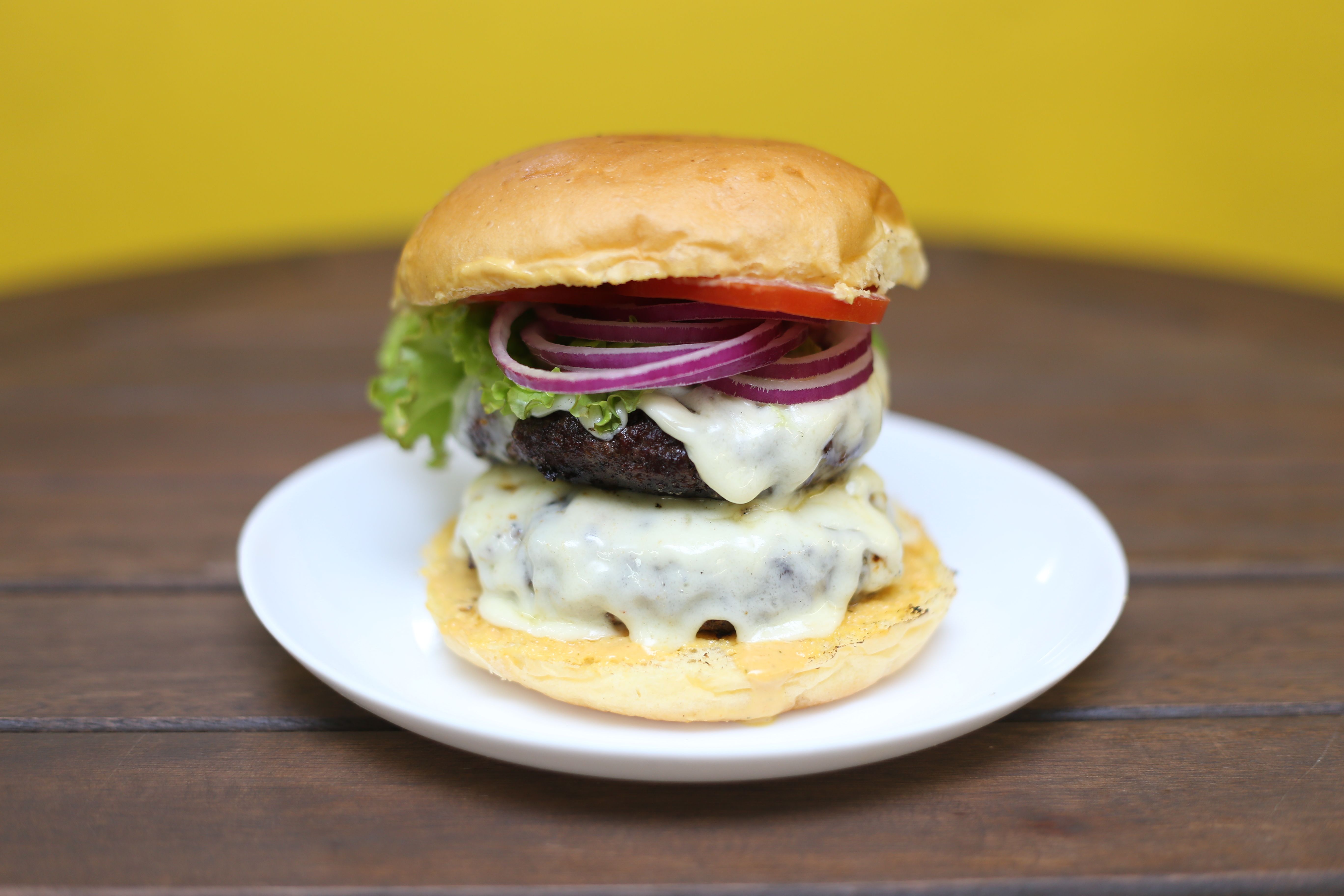 Close-Up Shot of a Burger on a White Plate · Free Stock Photo