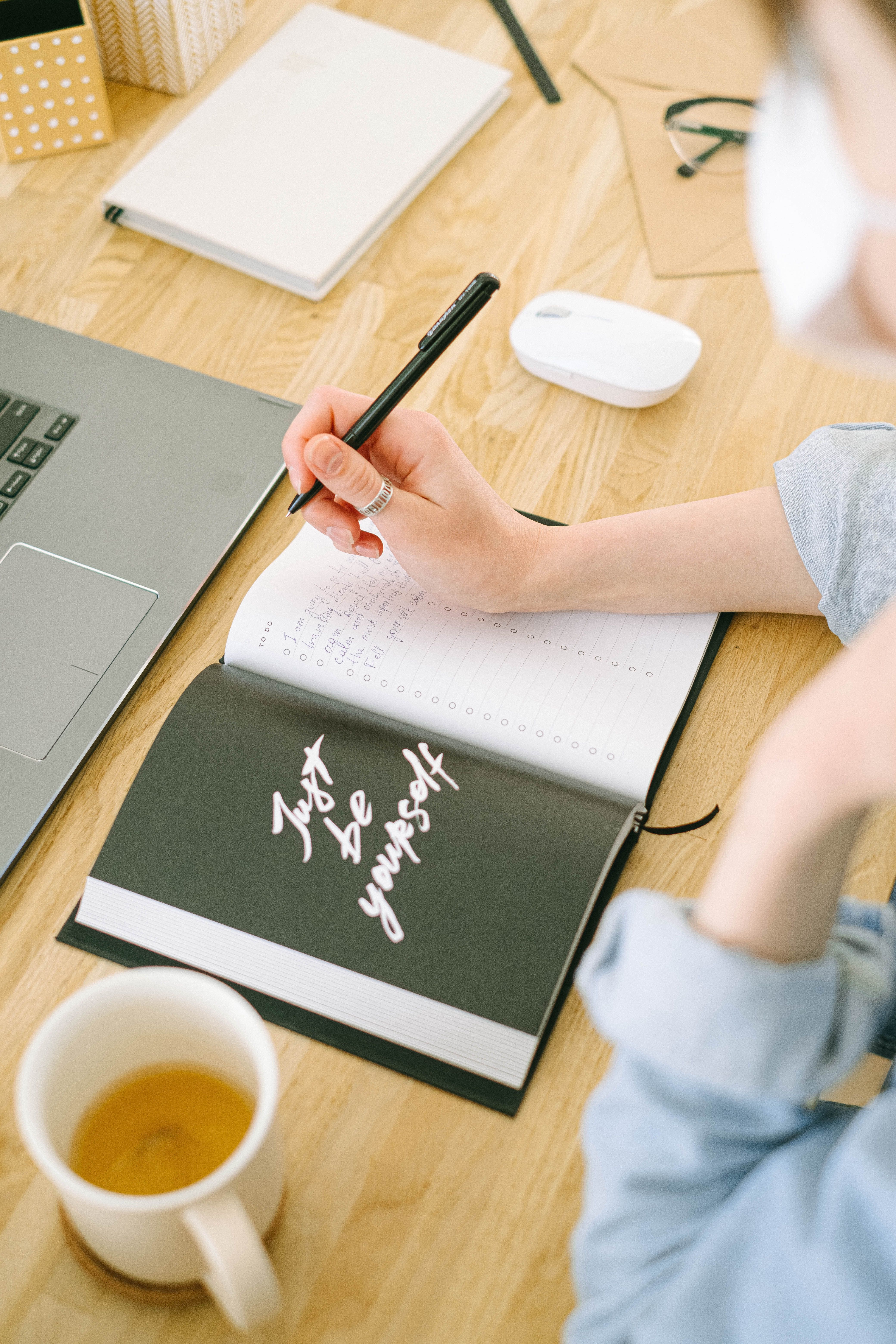 Person Writing in Notebook · Free Stock Photo