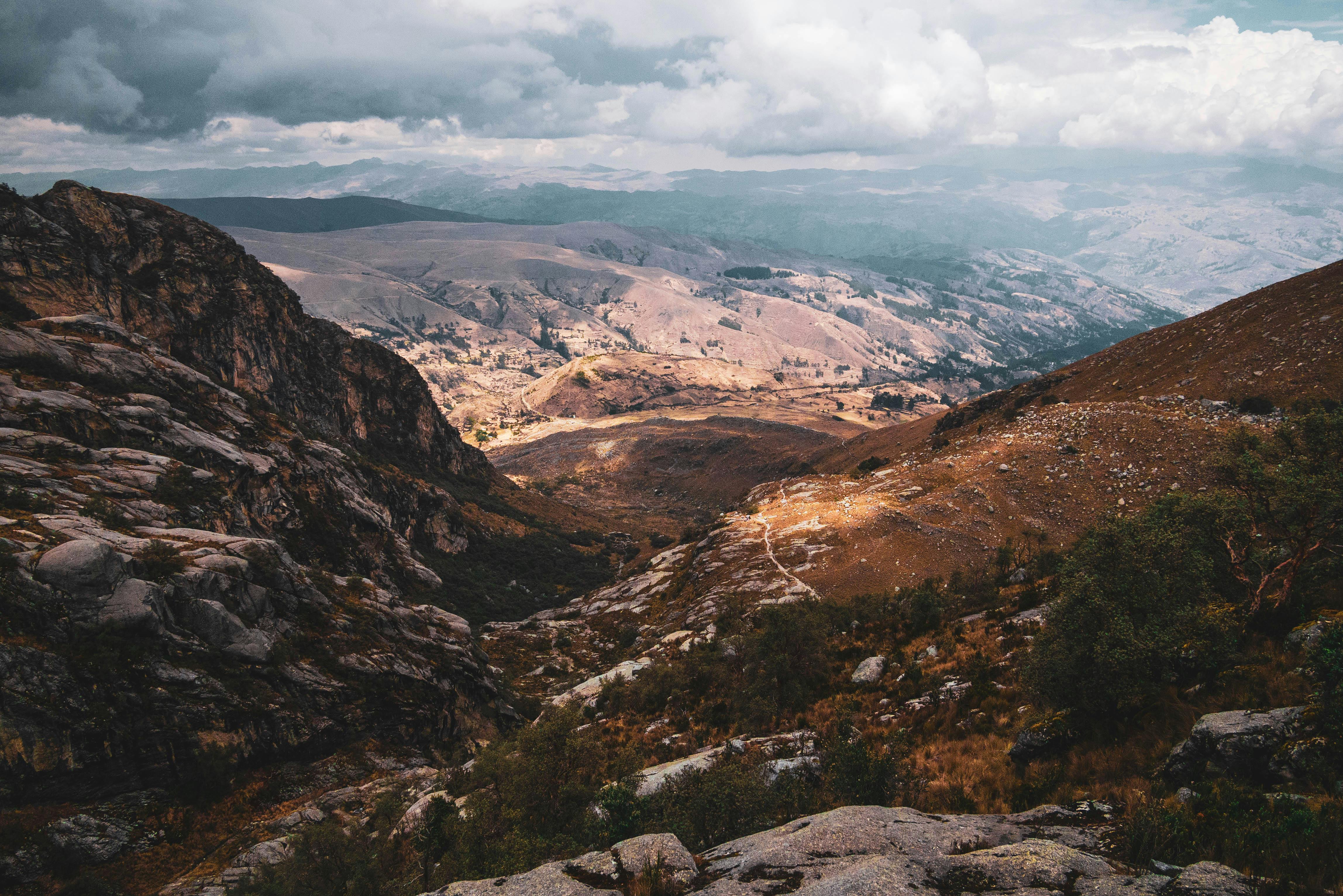 Landscape Scenery of Brown Mountains under Cloudy Sky · Free Stock Photo