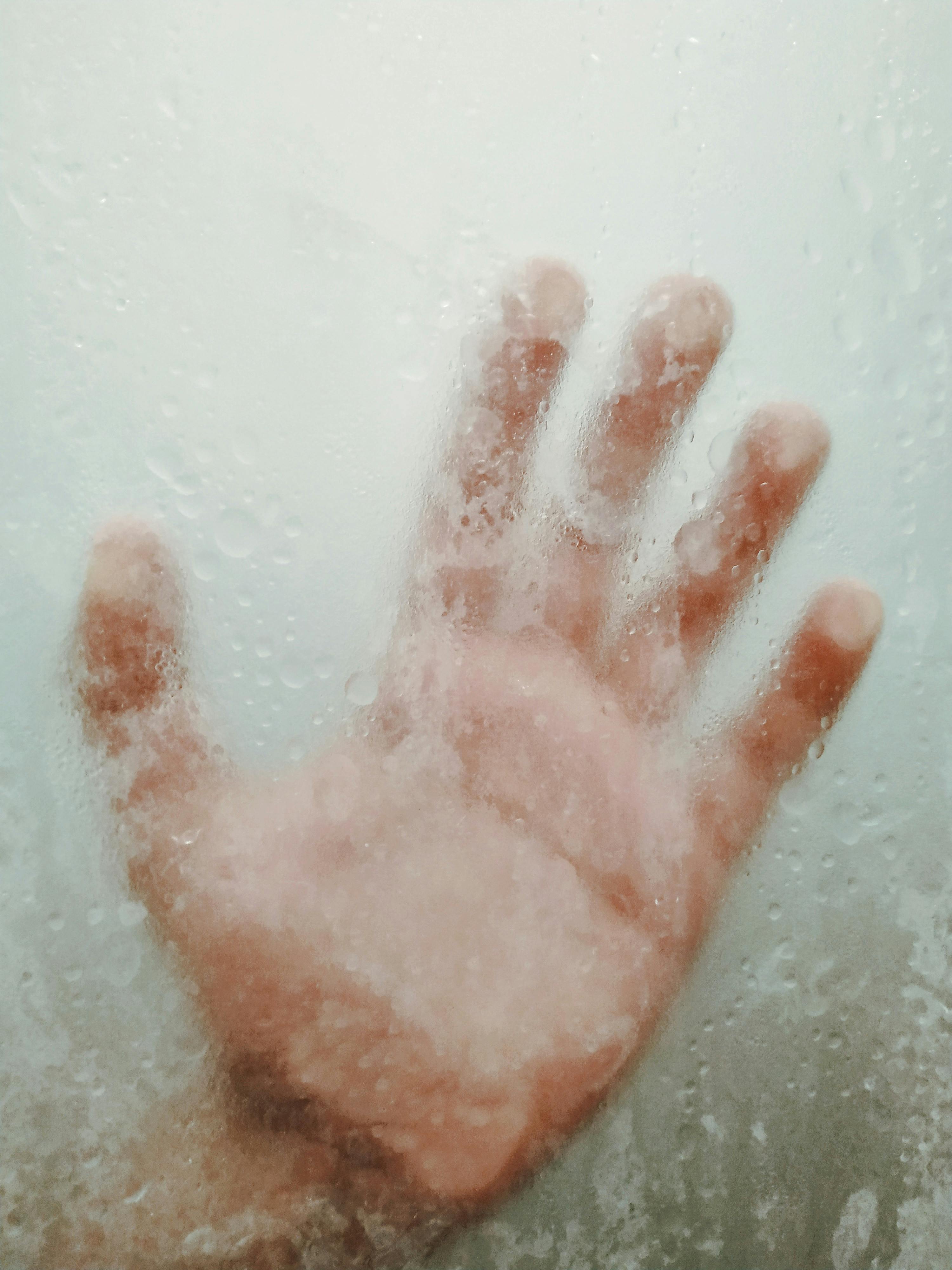 Persons Hand on Glass Window · Free Stock Photo