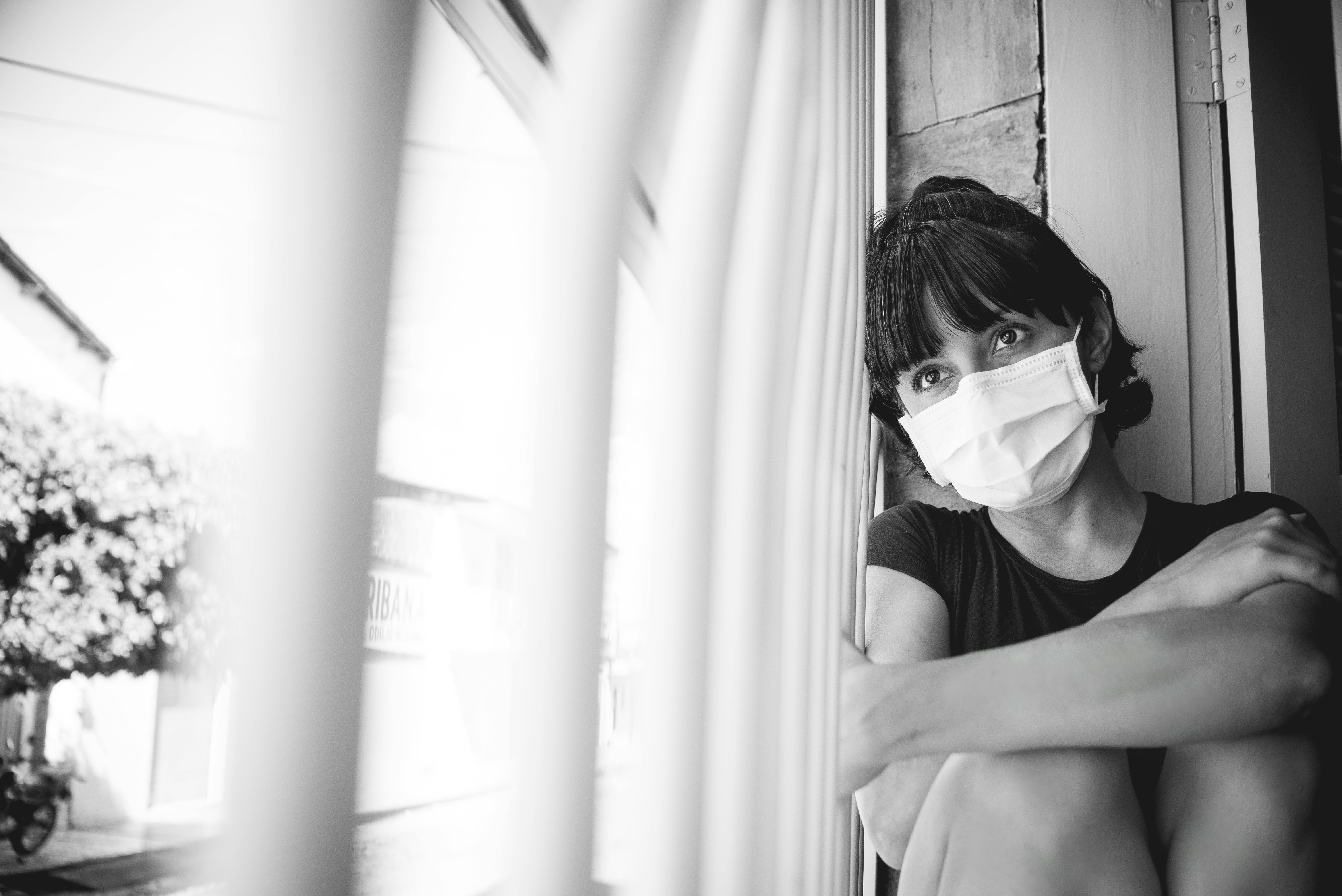 Grayscale Photo of a Lonely Woman Wearing Face Mask · Free Stock Photo