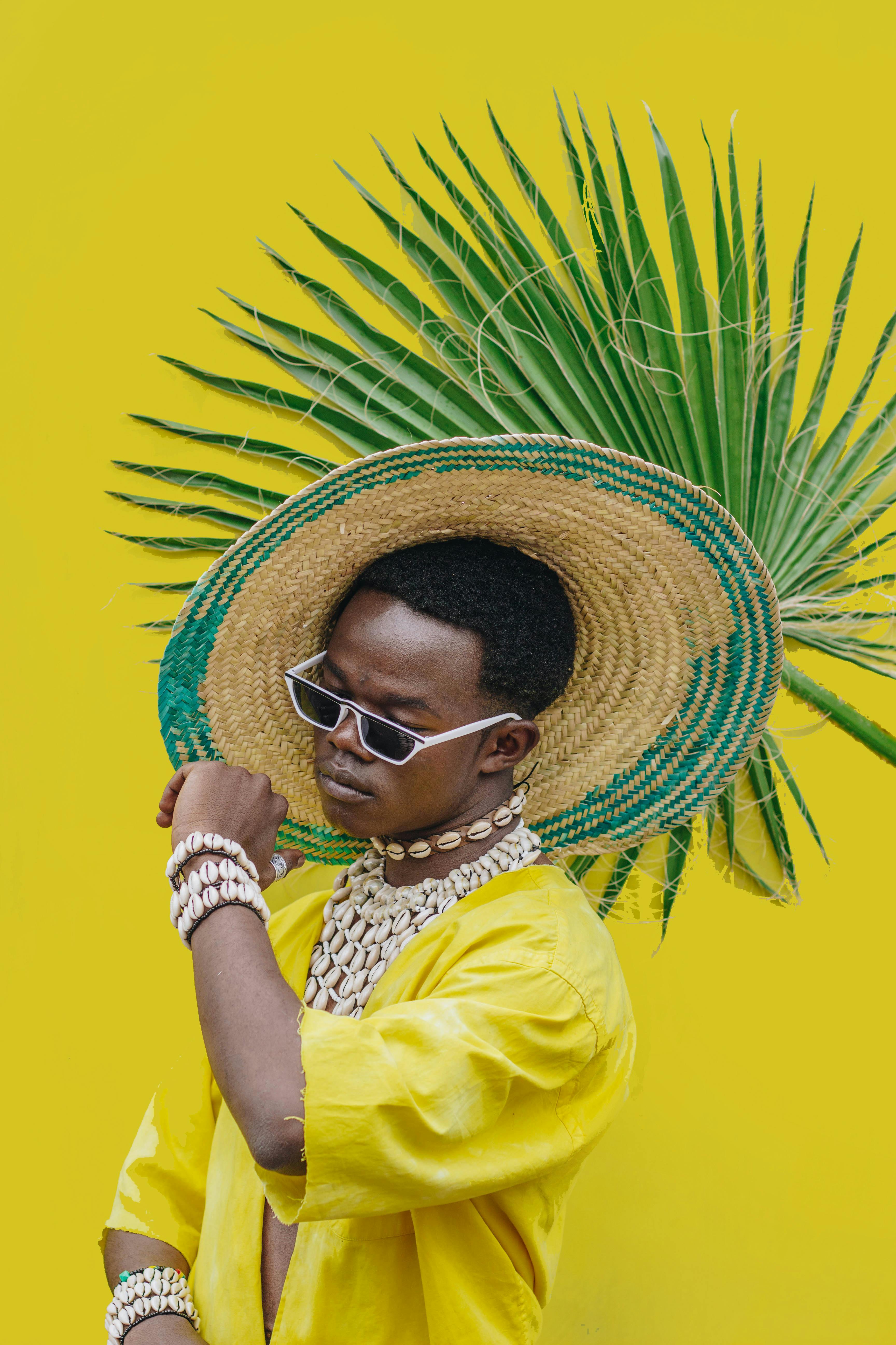 A Man Wearing Shell Accessories and a Straw Hat · Free Stock Photo