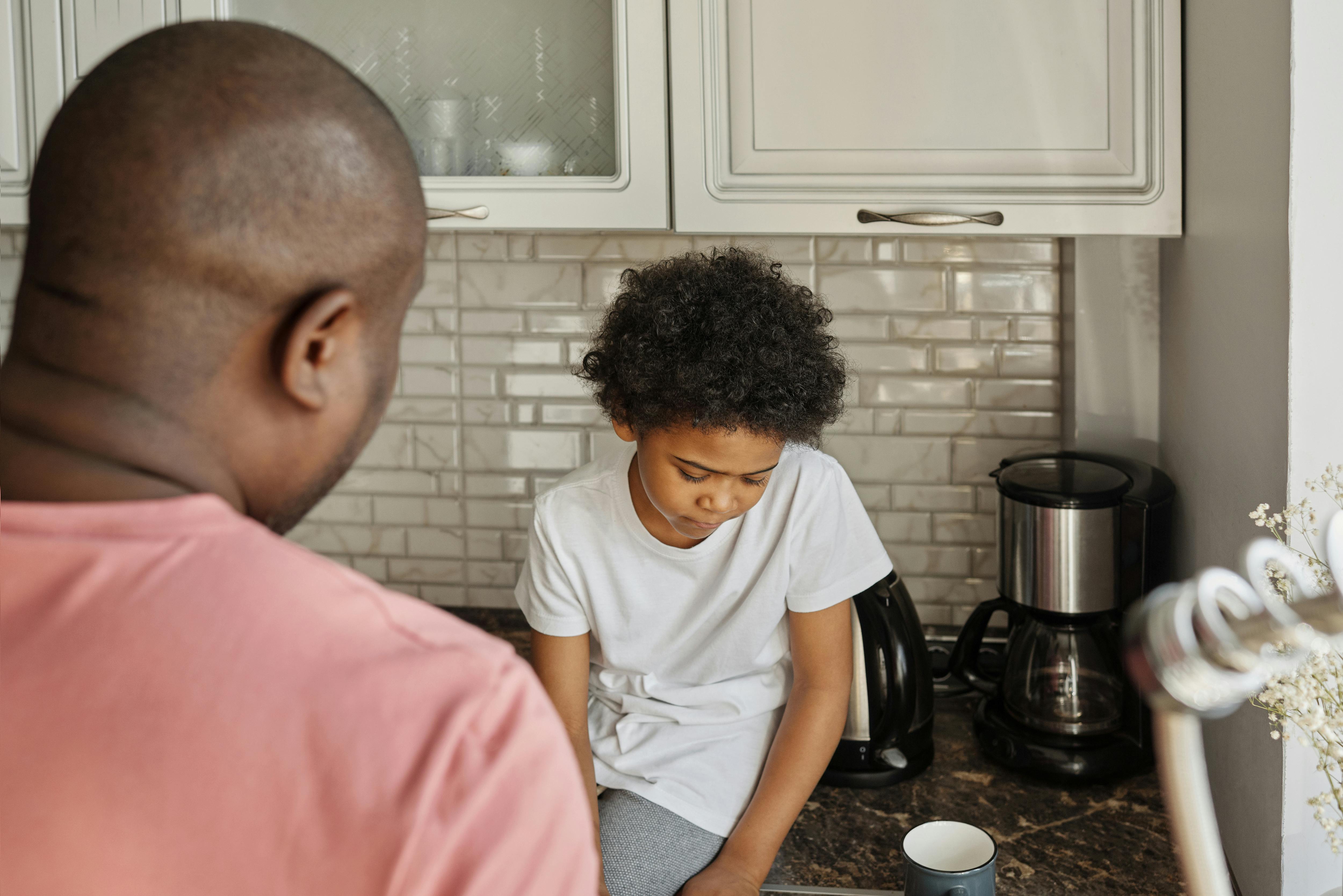 Little Boy Sitting on the Kitchen Counter · Free Stock Photo