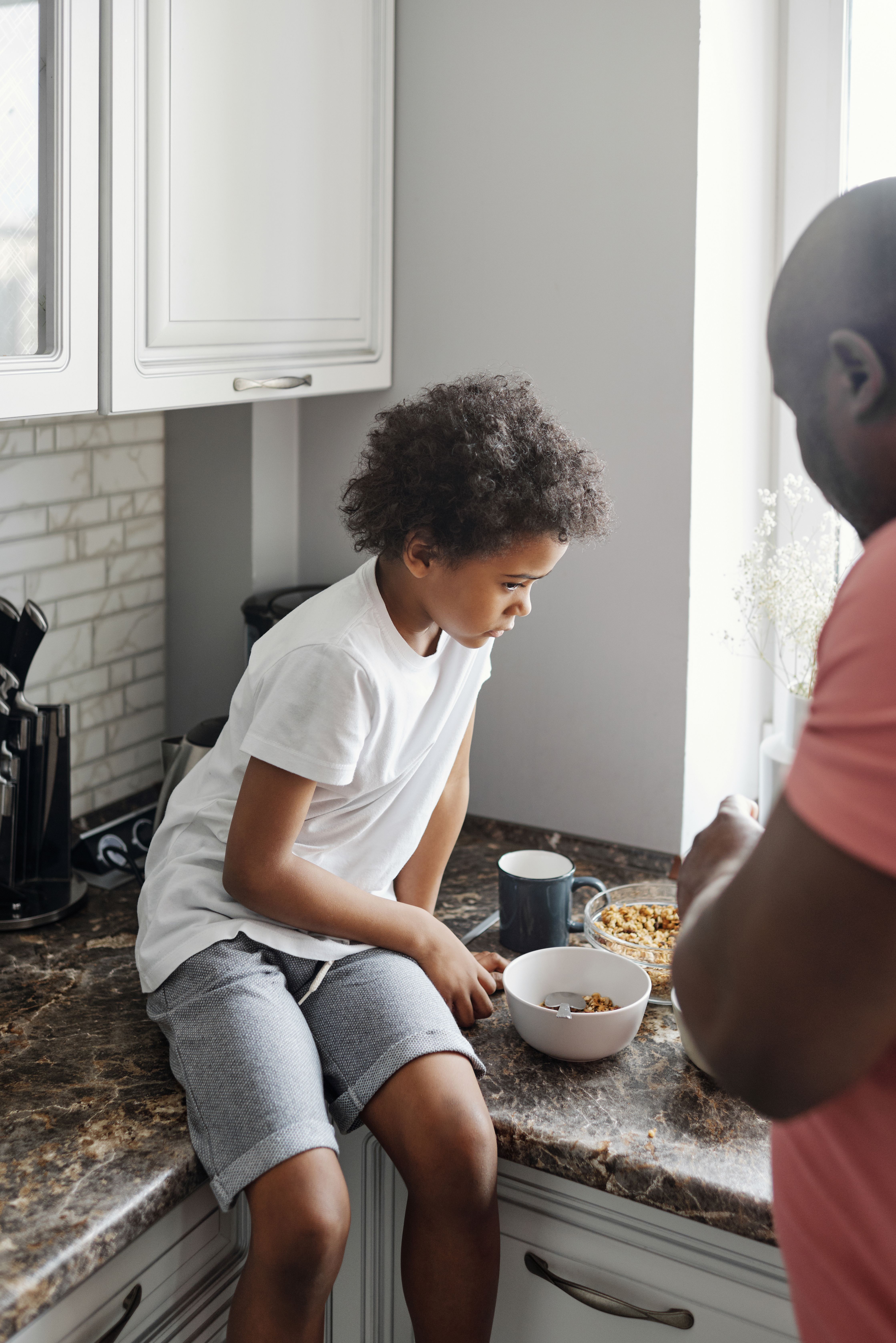 Boy Sitting on the Kitchen Counter · Free Stock Photo