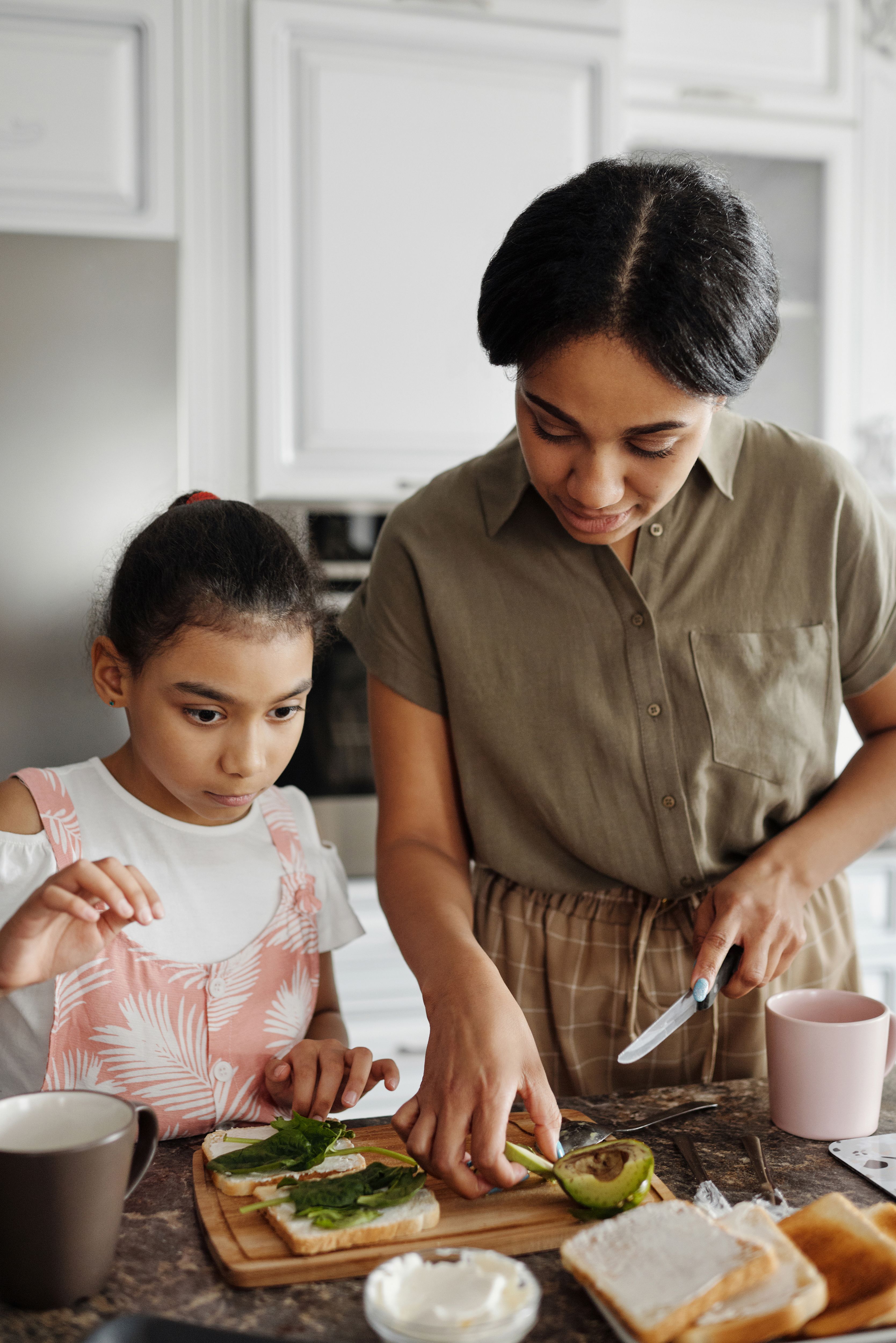 Mother and Daughter Preparing Avocado Toast · Free Stock Photo