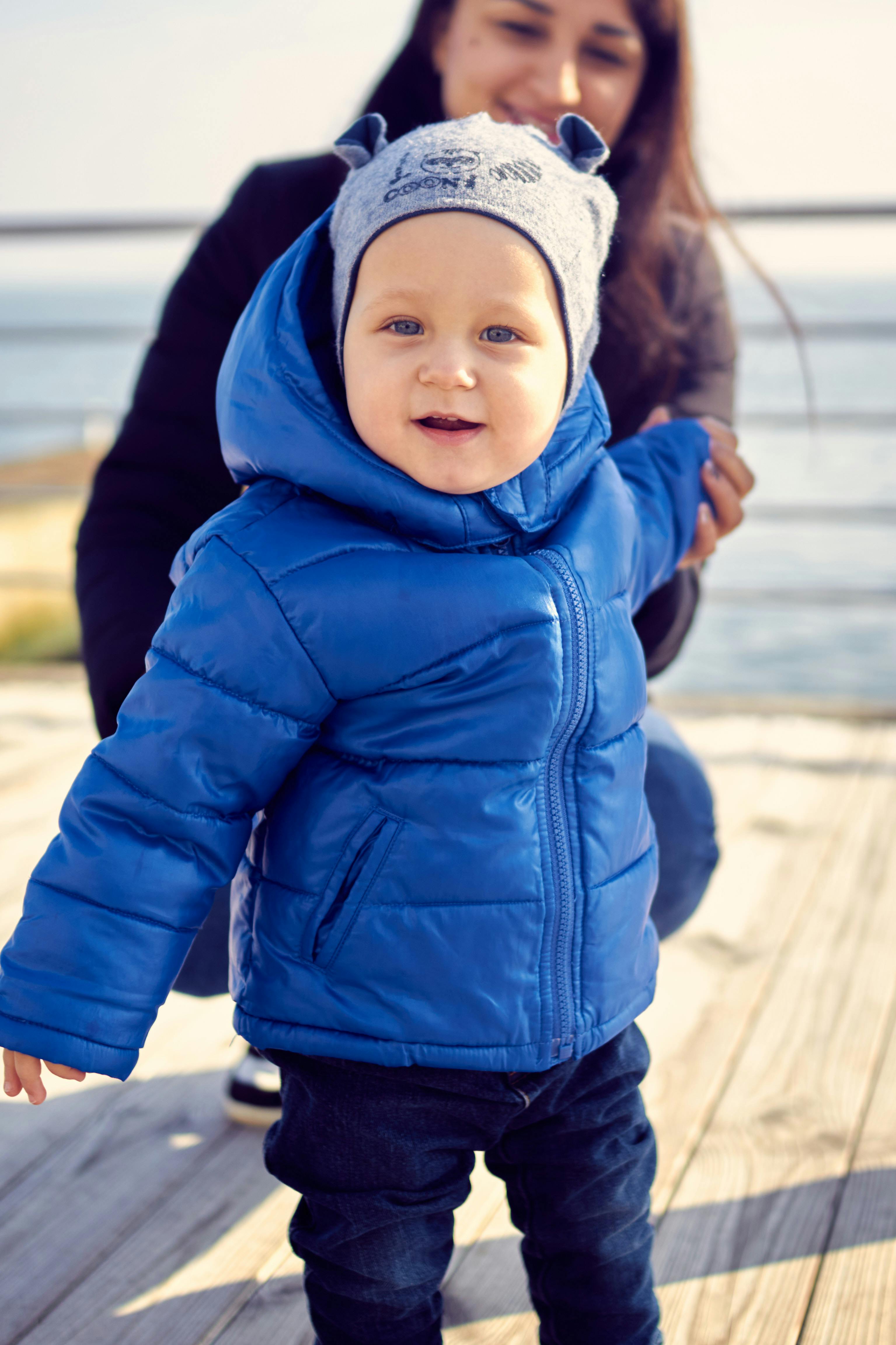 Selective Focus Photo of an Adorable Kid in a Blue Puffer Jacket · Free ...