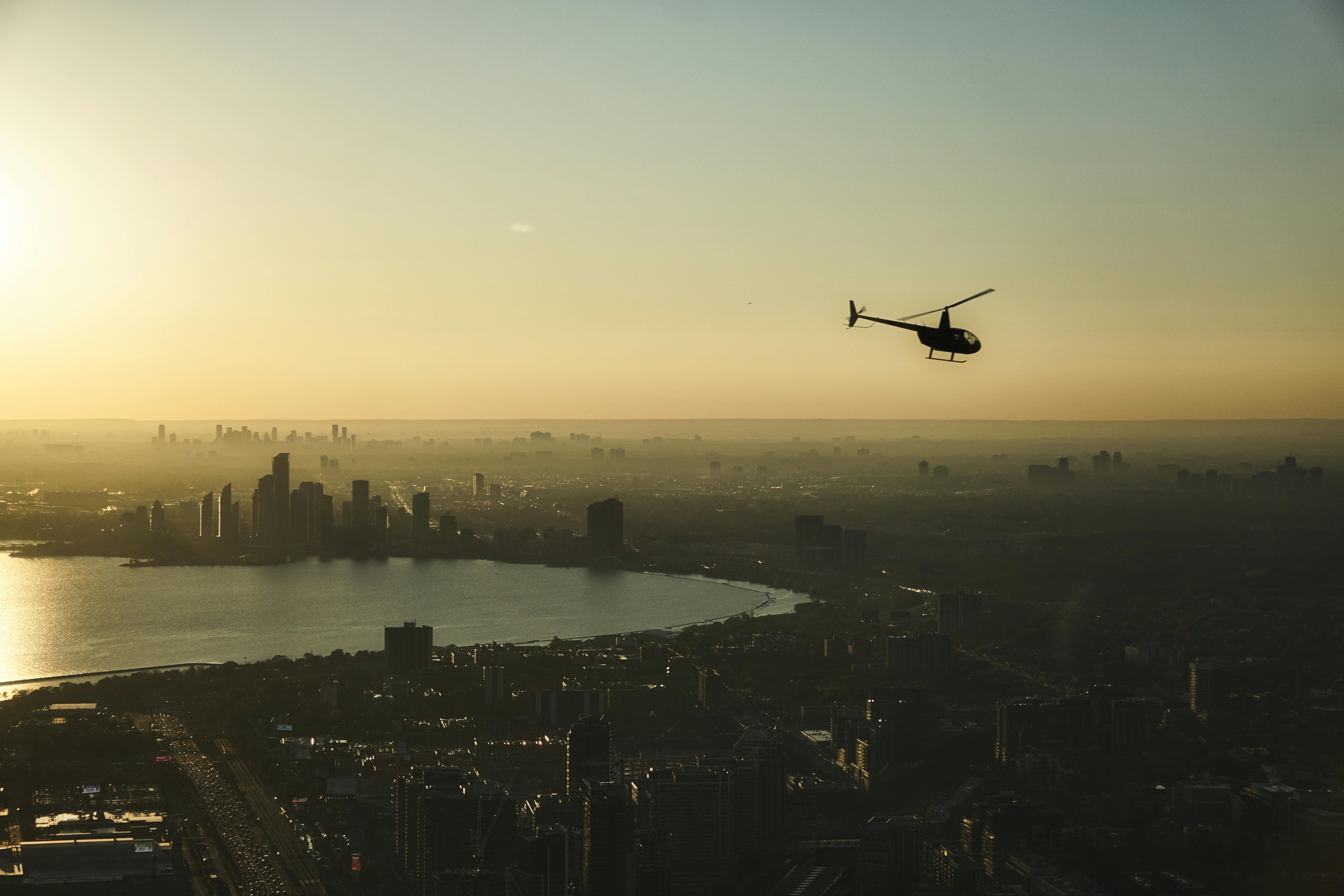 A Helicopter Flying over a Cityscape · Free Stock Photo