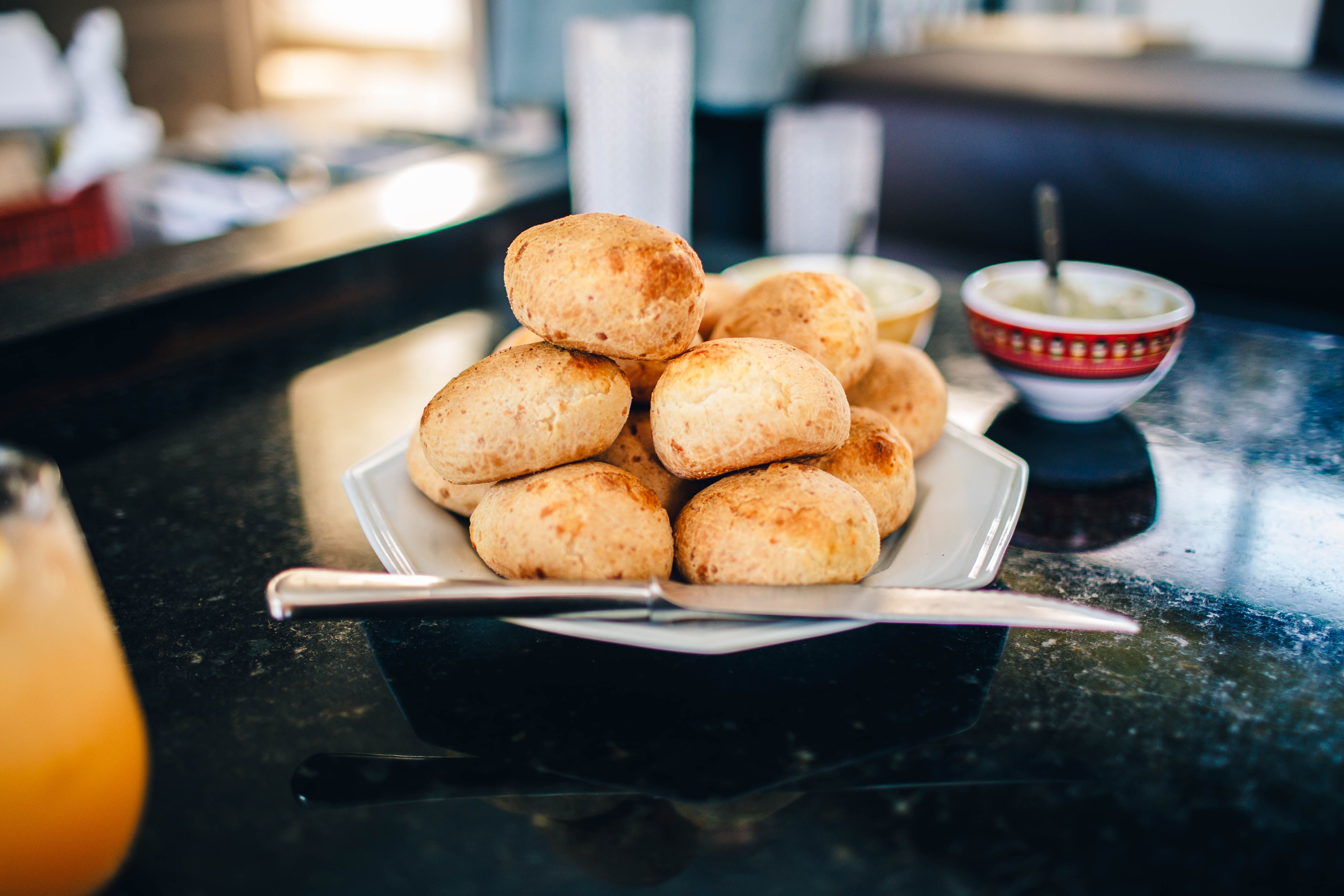 Delicious Crunchy Buns on a White Ceramic Plate · Free Stock Photo