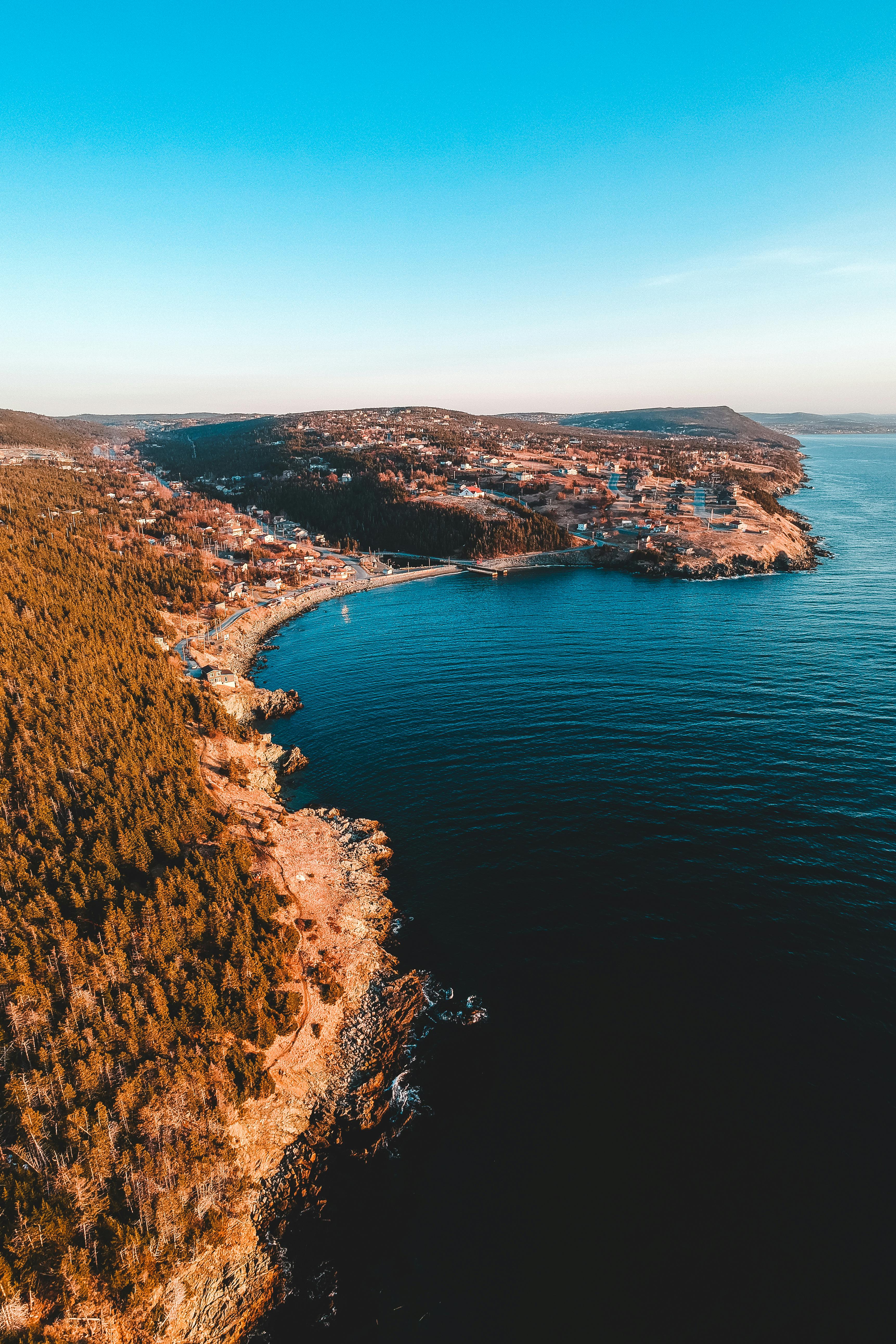Breathtaking view of ocean near ridge under blue cloudy sky · Free ...