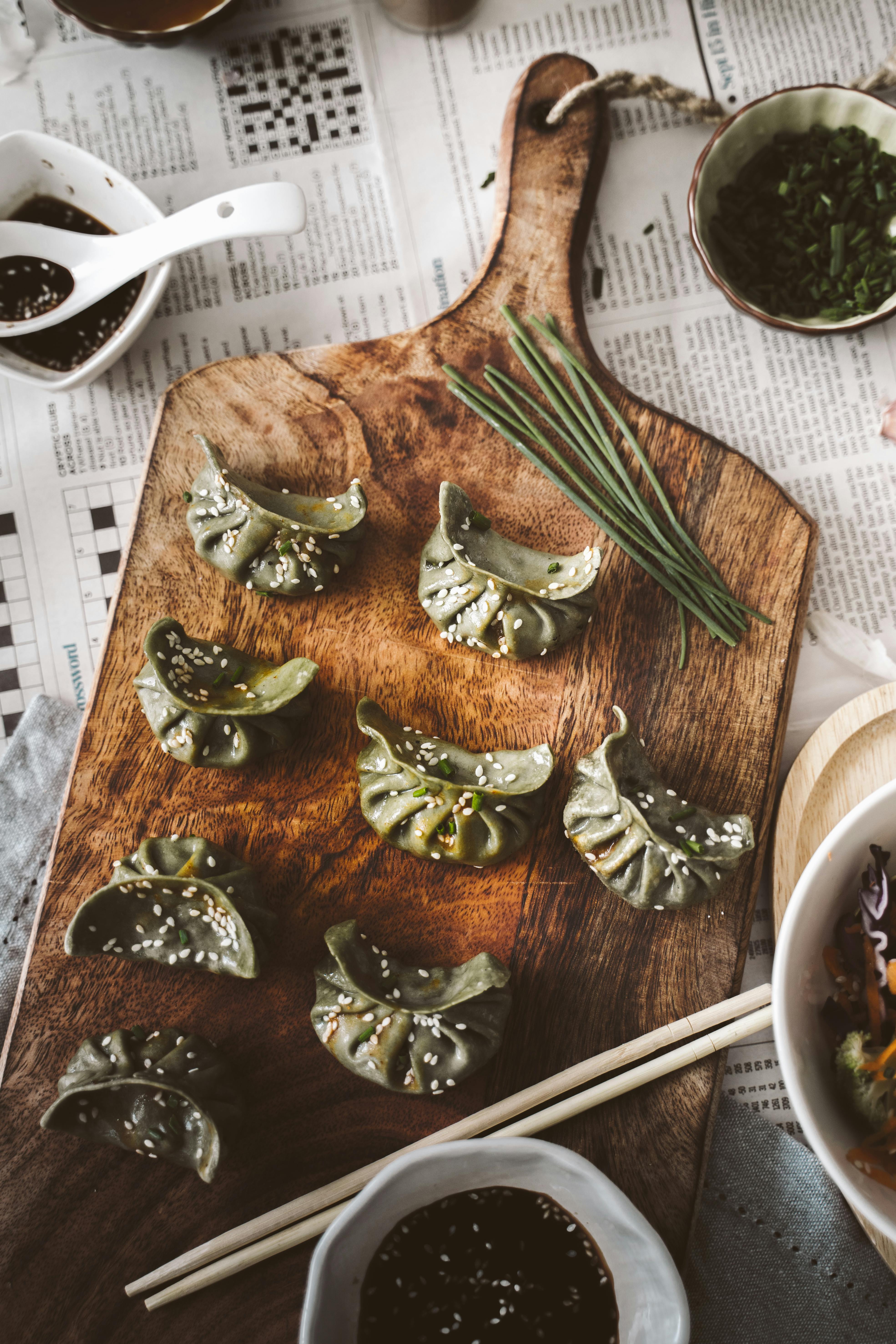 Photo Of Green Dumplings On Top Of Wooden Chopping Board · Free Stock Photo