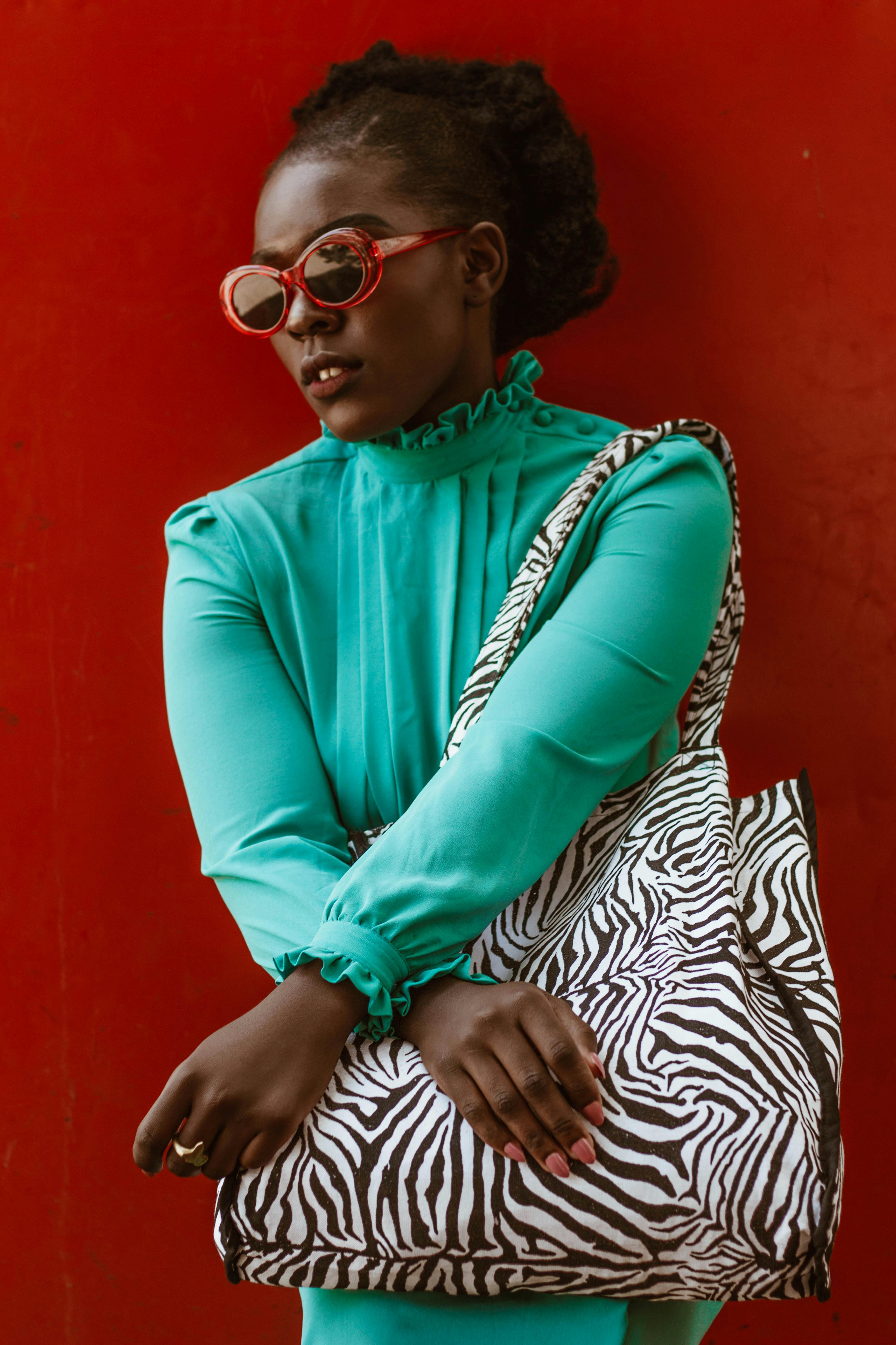 African Woman Posing on Chair in a Studio · Free Stock Photo