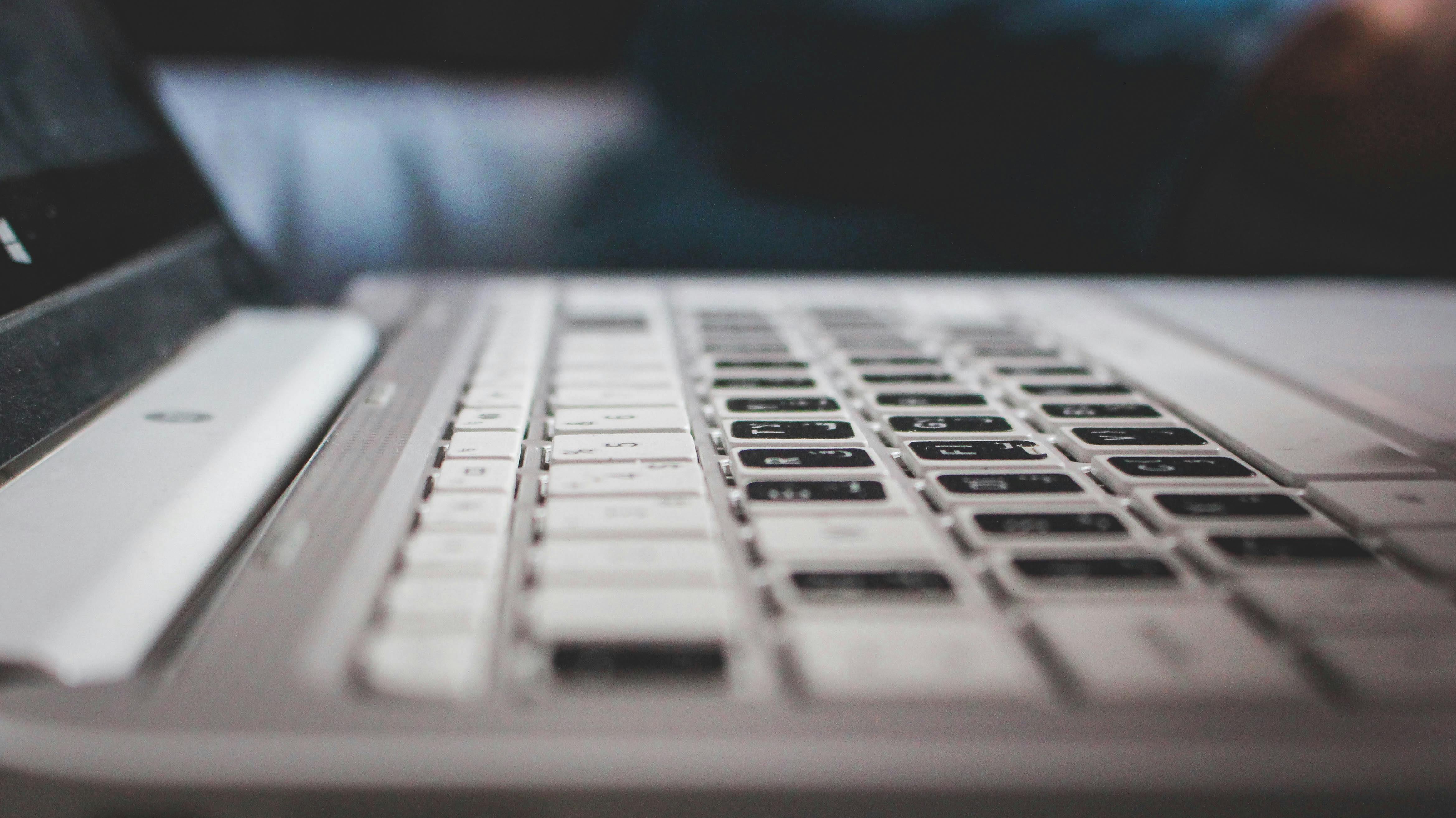Modern laptop keyboard with black and white keys · Free Stock Photo