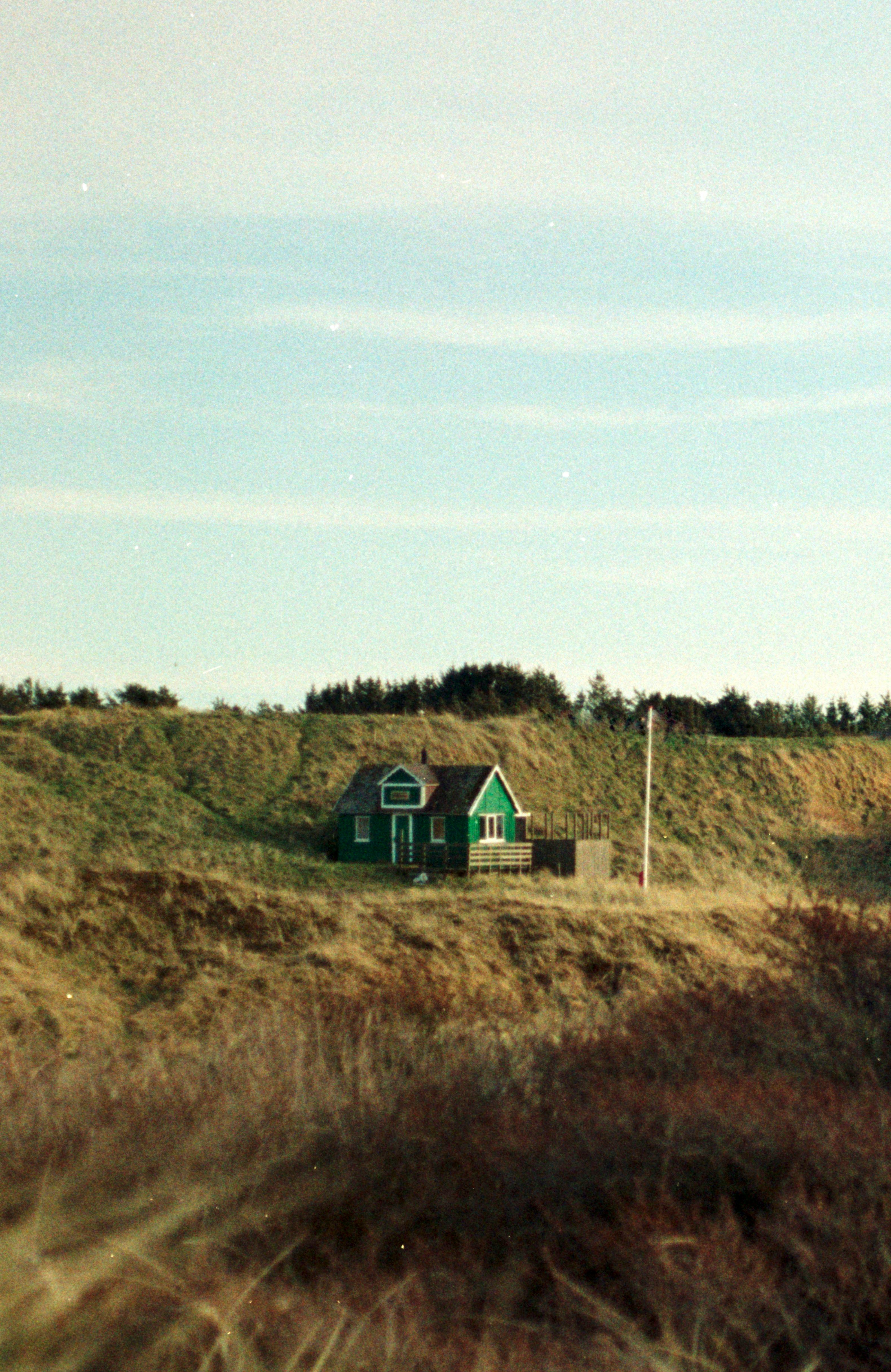 Rural remote cottage on grassy meadow · Free Stock Photo