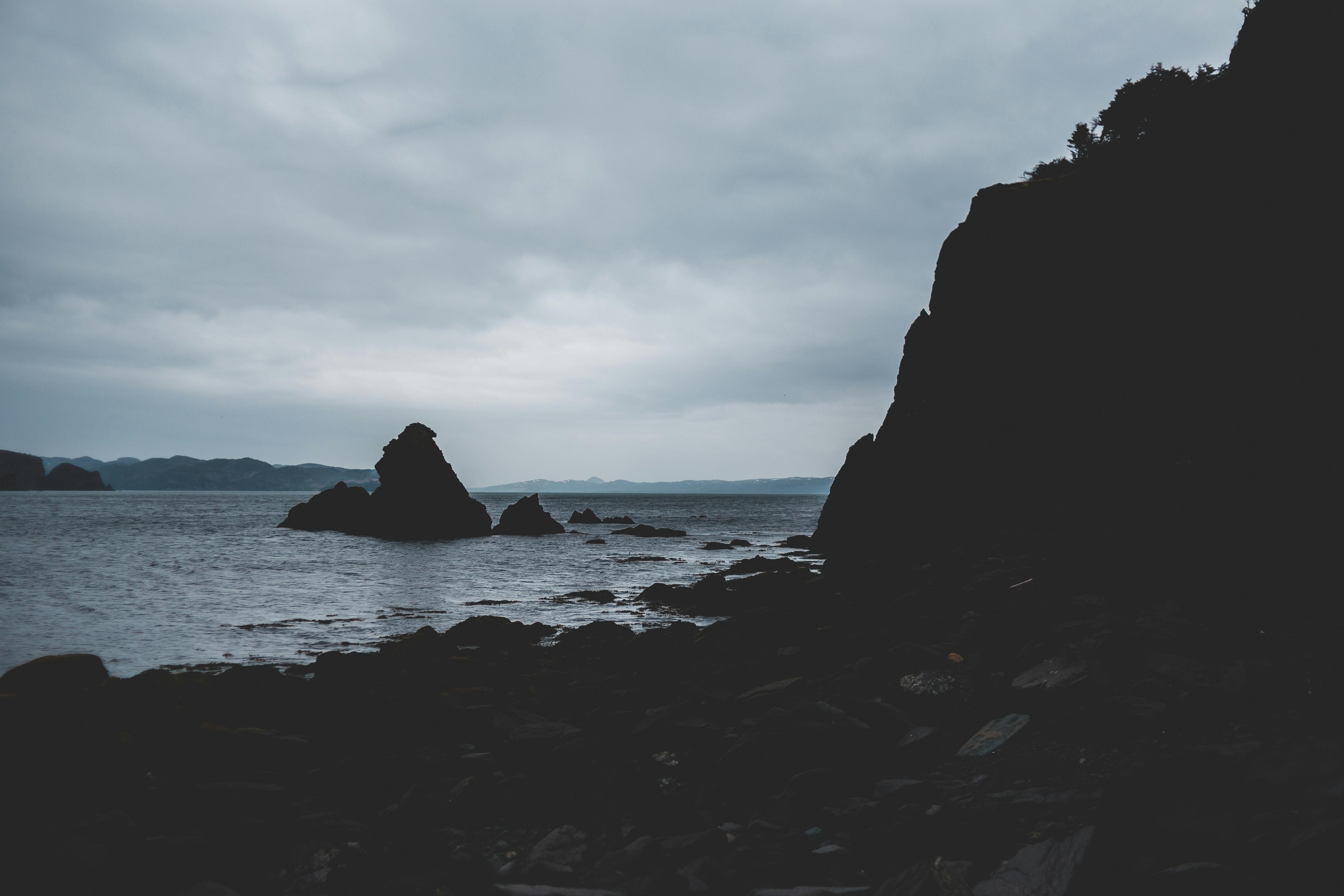 Rocky seashore of sea in overcast weather · Free Stock Photo