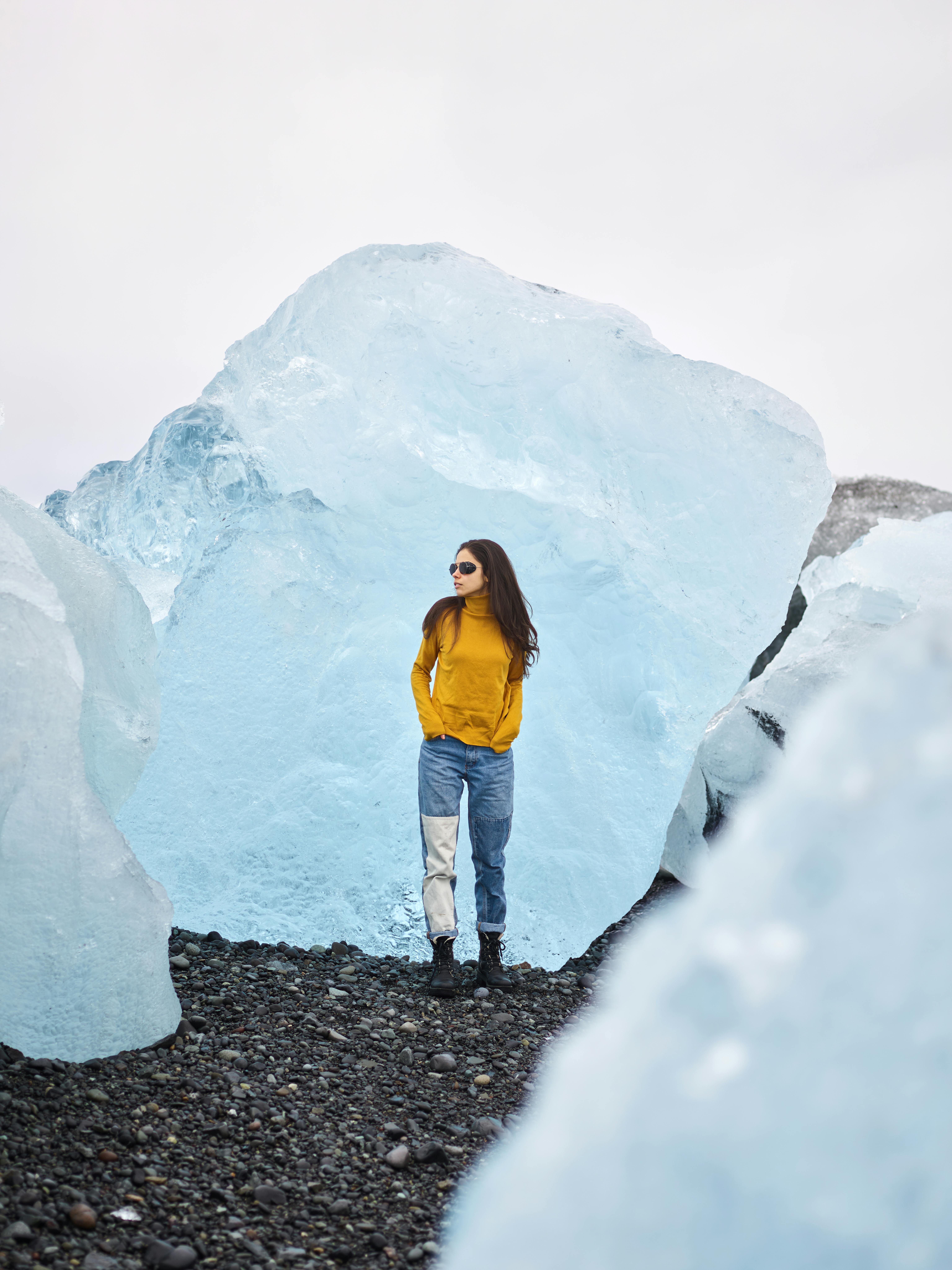 Female tourist standing among ice blocks · Free Stock Photo