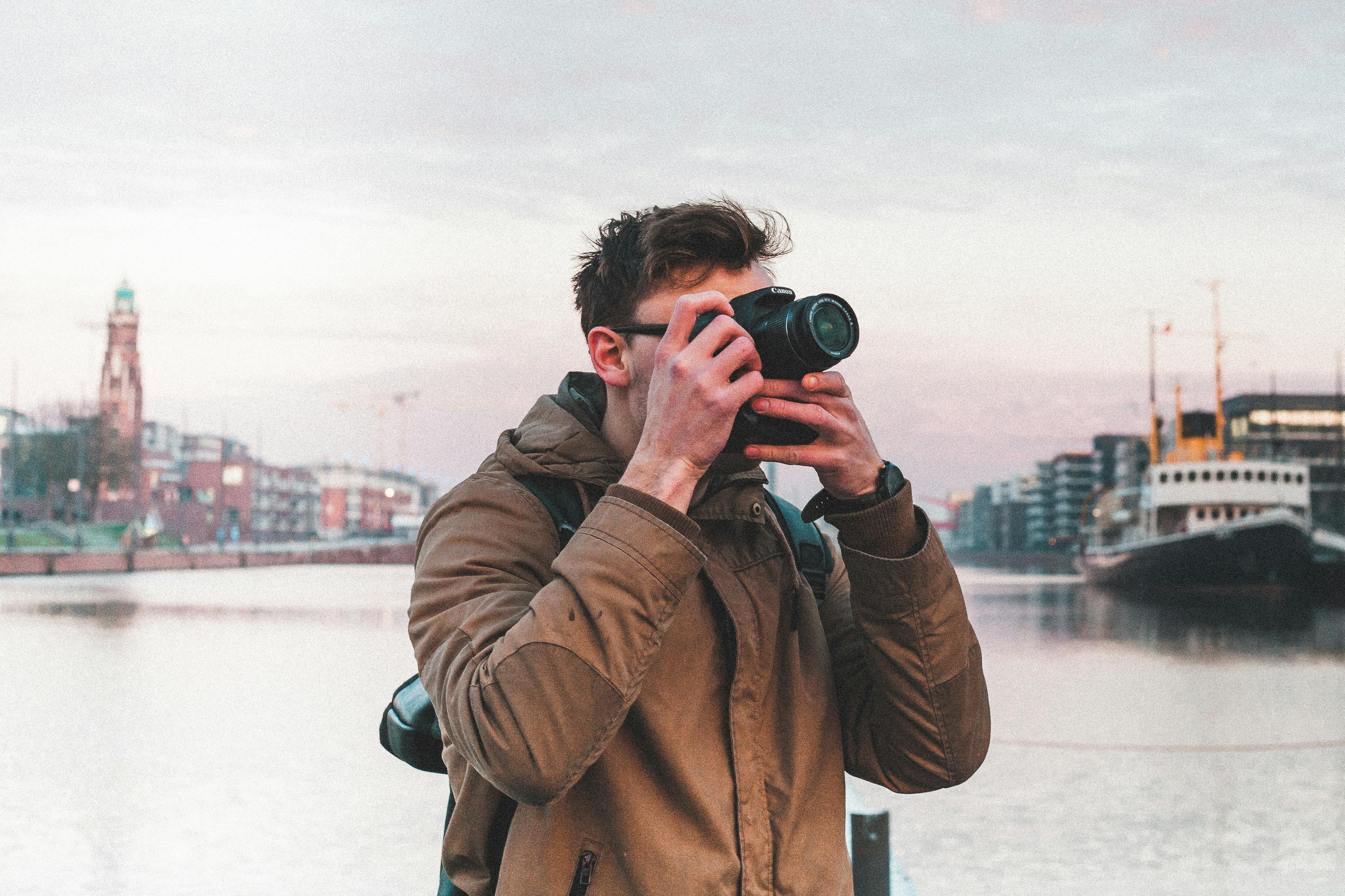 Photo of Man Taking Photo Using a Dslr Camera · Free Stock Photo
