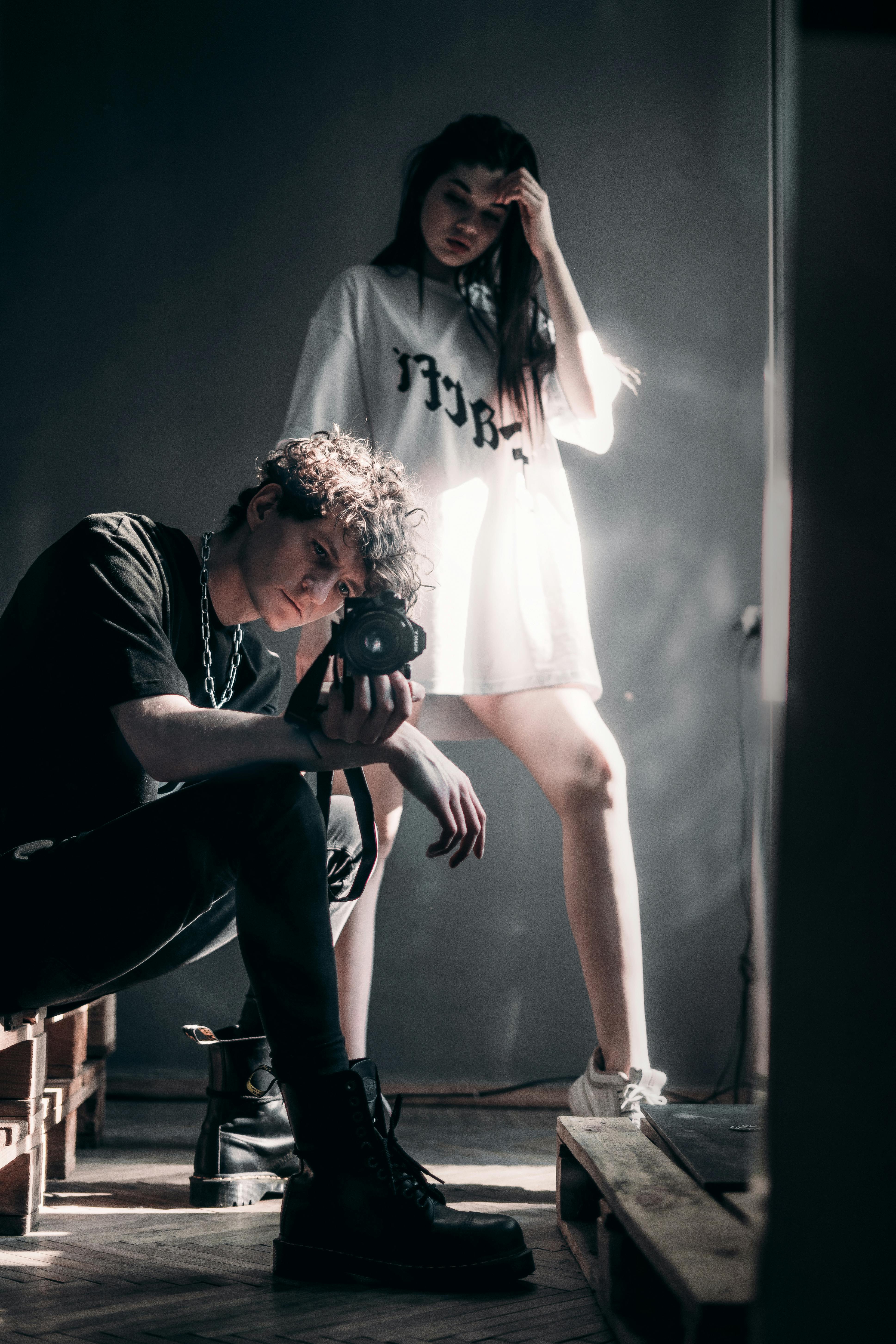 Creative photographer and model in studio · Free Stock Photo