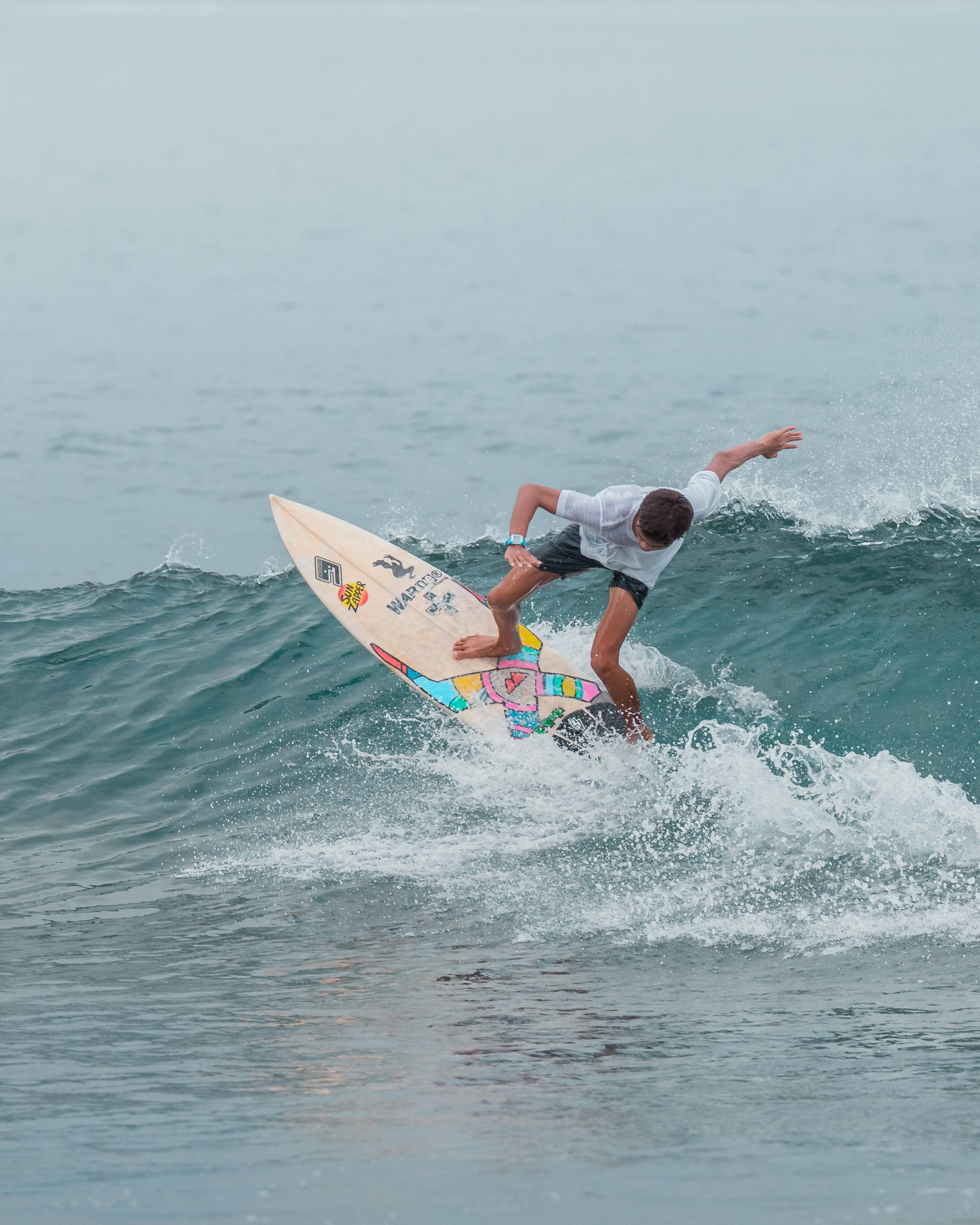 Man in White Shirt Surfing on Sea · Free Stock Photo