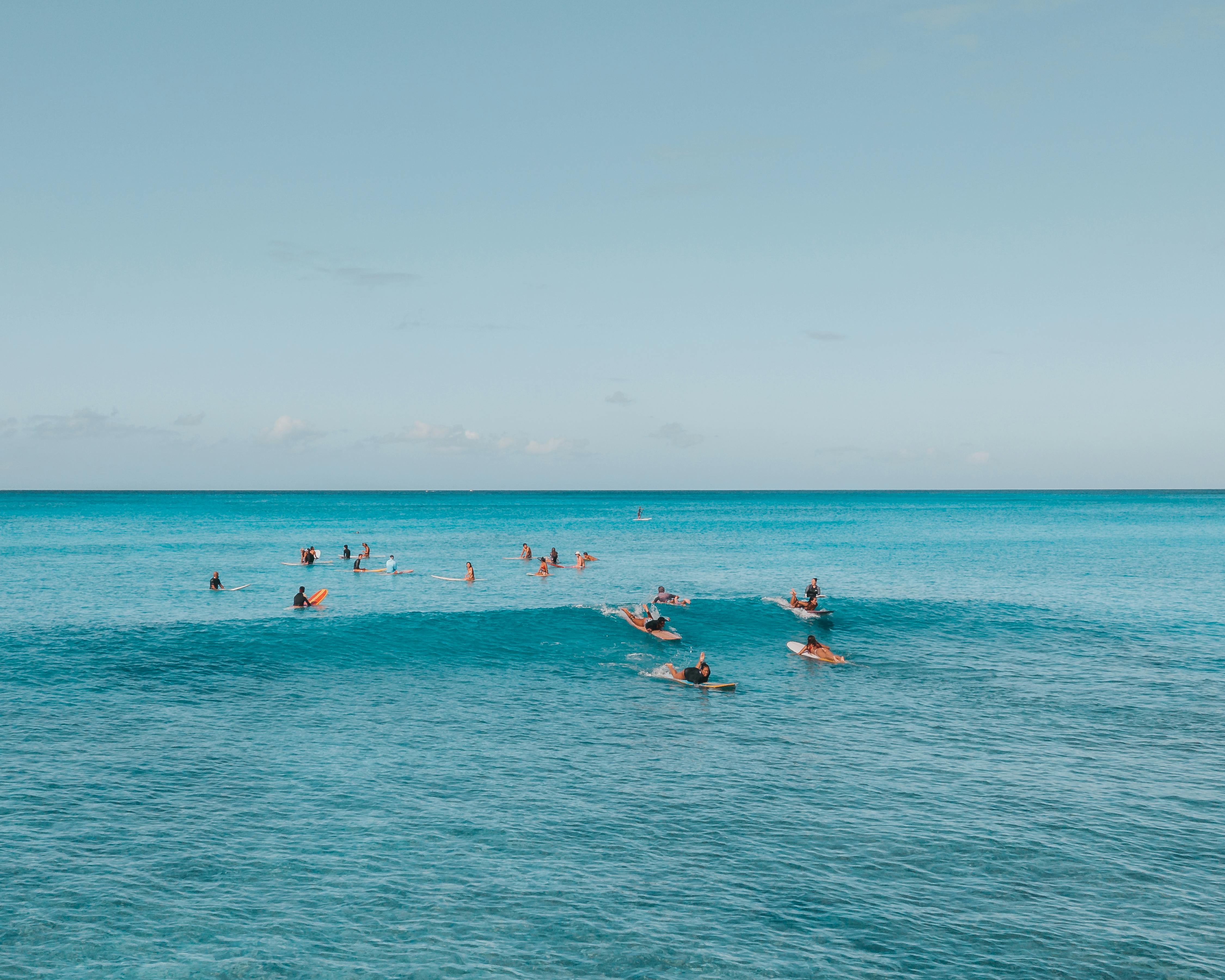 People Surfing on Sea · Free Stock Photo