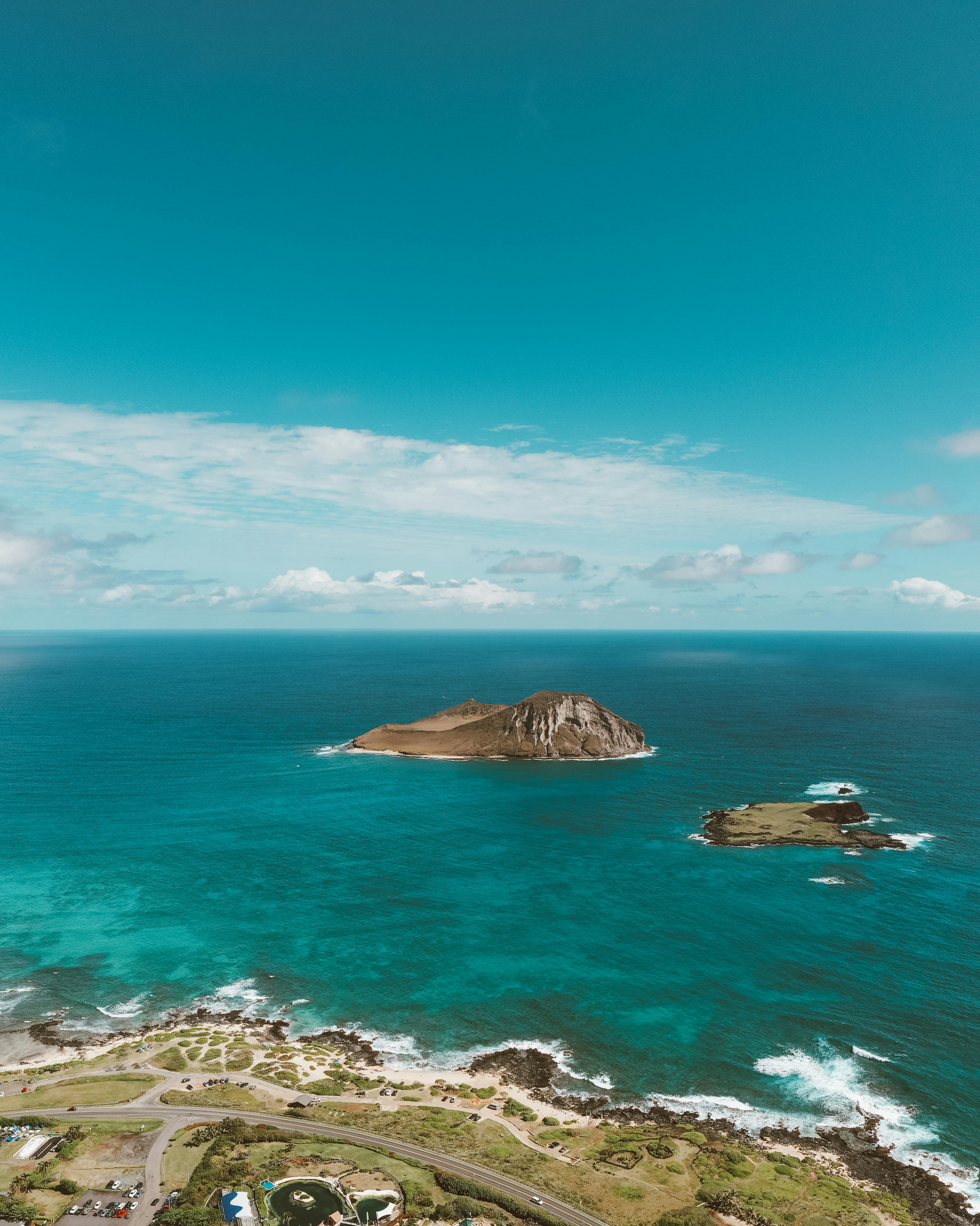 Brown Island on Blue Sea Under Blue the Sky · Free Stock Photo