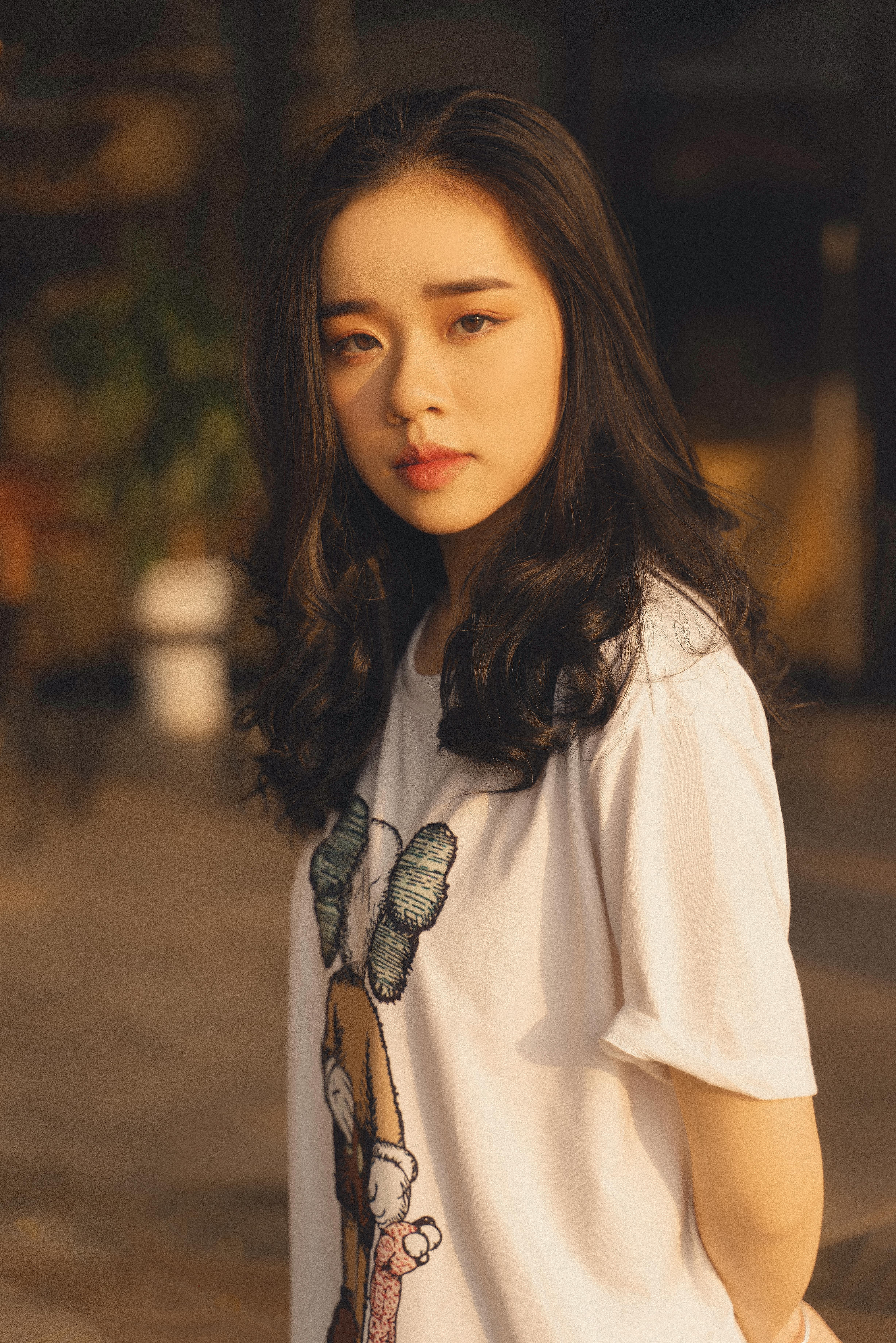 Stylish young Asian female millennial chilling on street · Free Stock Photo