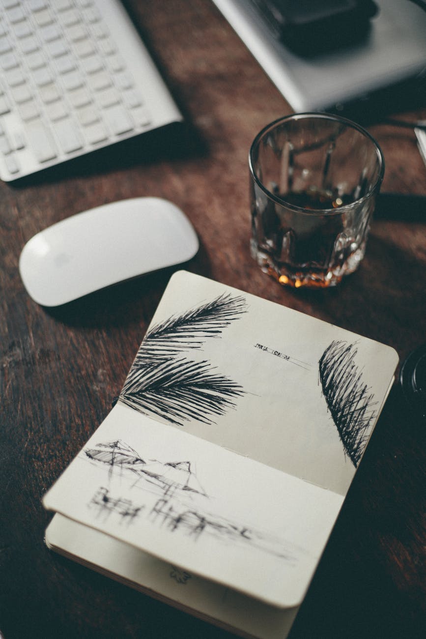 Clear Drinking Glass Beside Apple Magic Mouse On Brown Wooden Table Free Stock Photo clear-drinking-glass-beside-apple-magic-mouse-on-brown-wooden-table-free-stock-photo